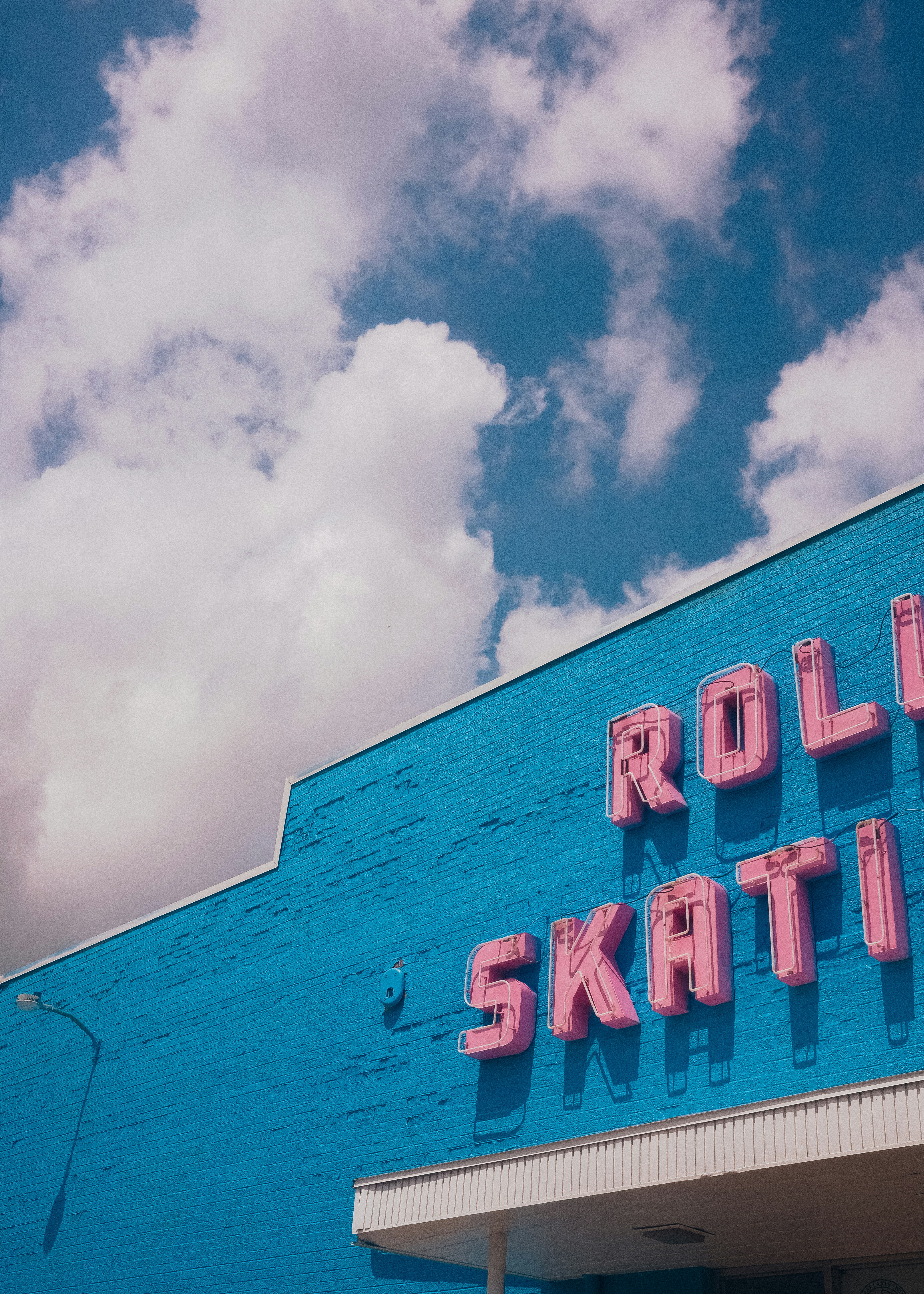 Neon Blue Facade: A Midday Sign Outlines the Sky
