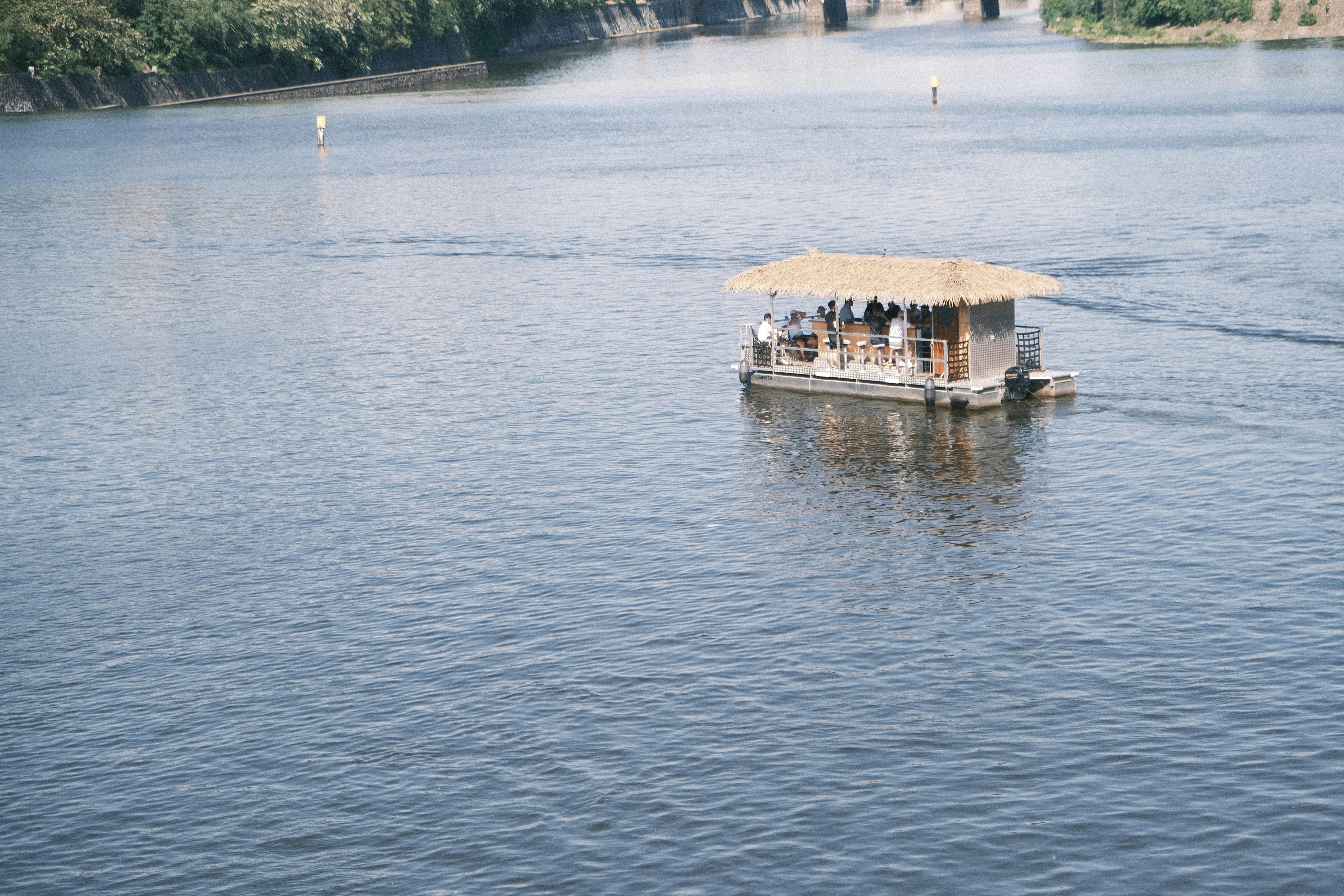 Sunlit Houseboat Drifting Across a Quiet River