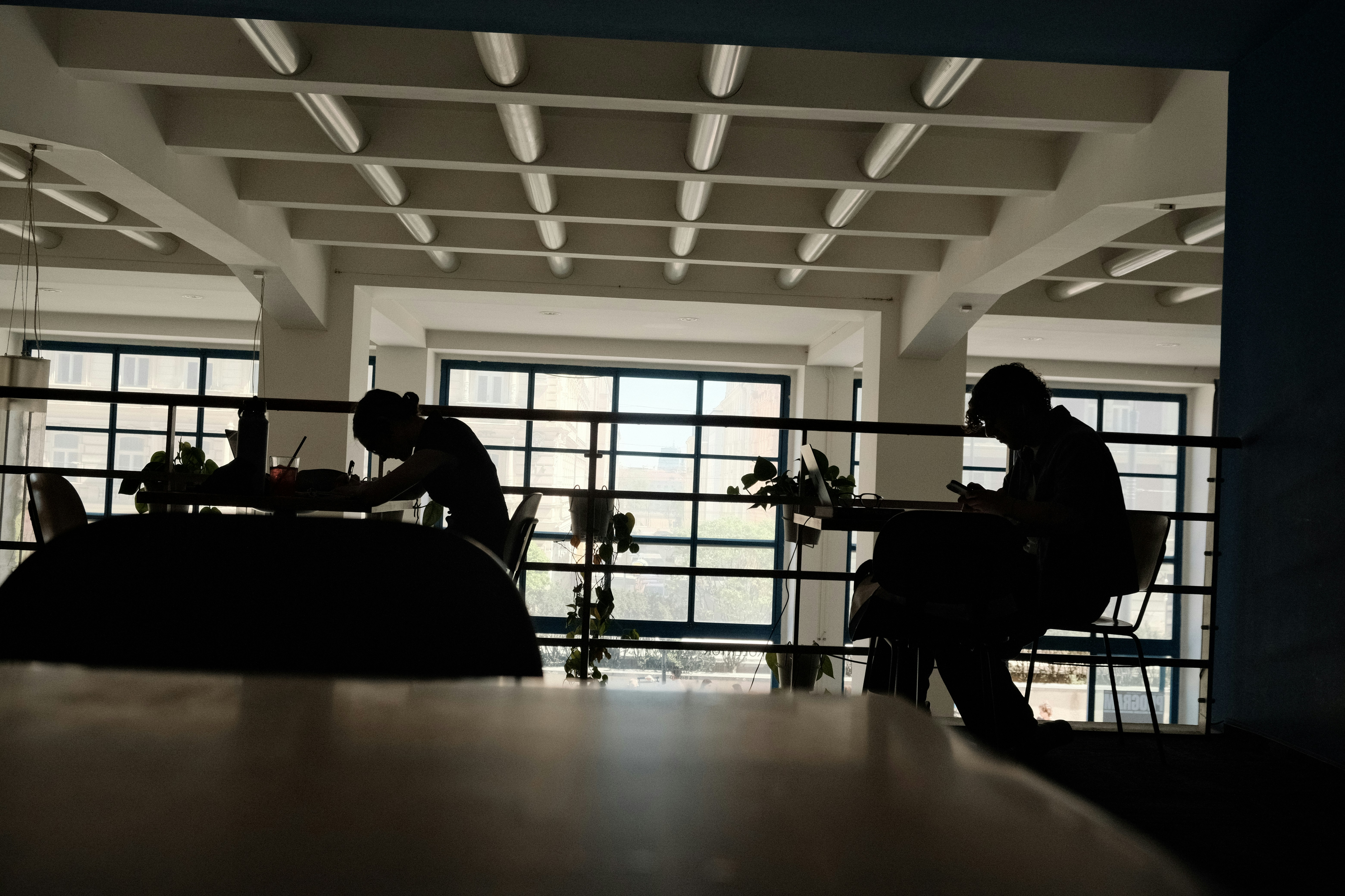 Silhouetted Craft: Two Artists at Dusk in a Quiet Studio