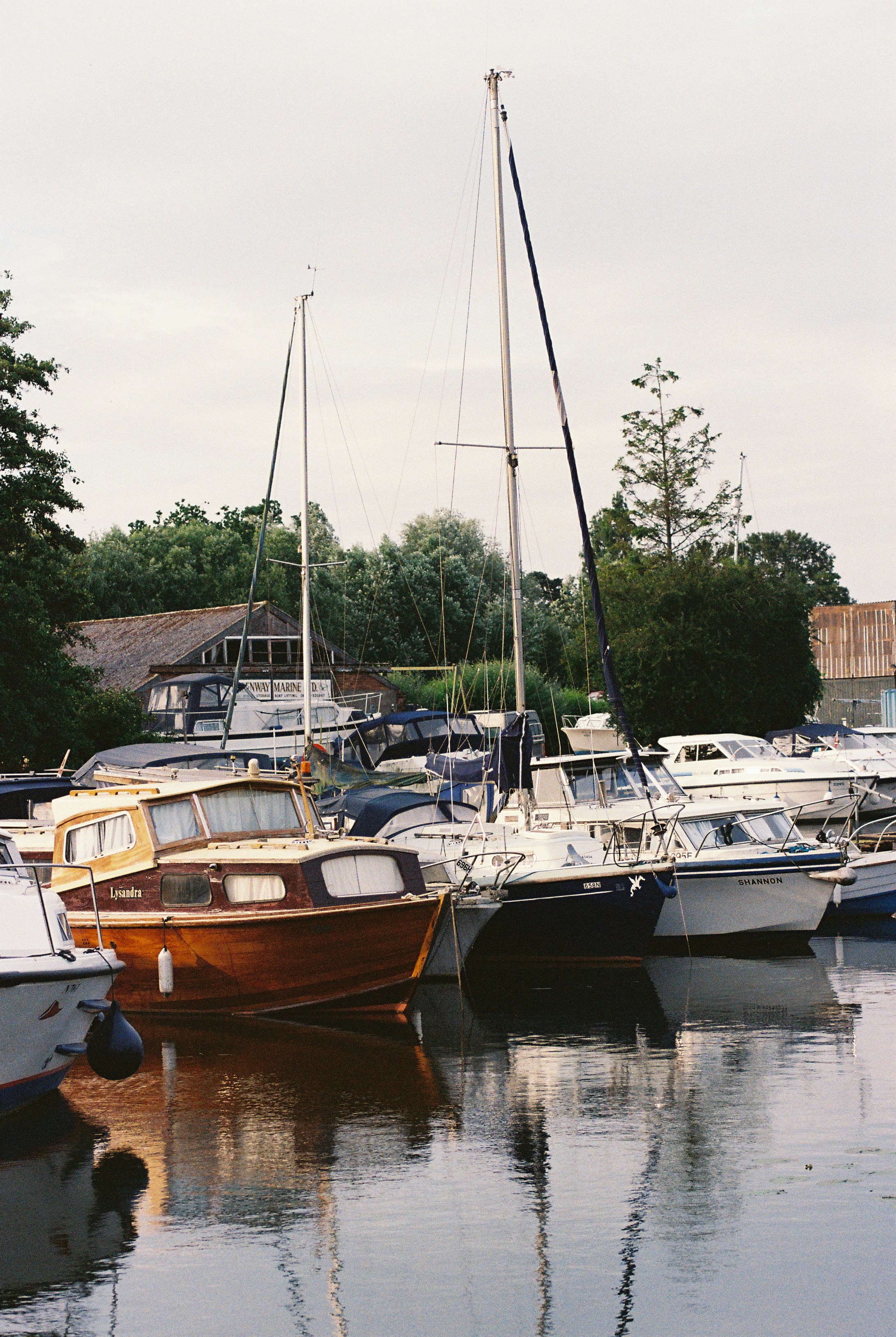 Dockside Echoes: Boats Resting Along a Calm Marina