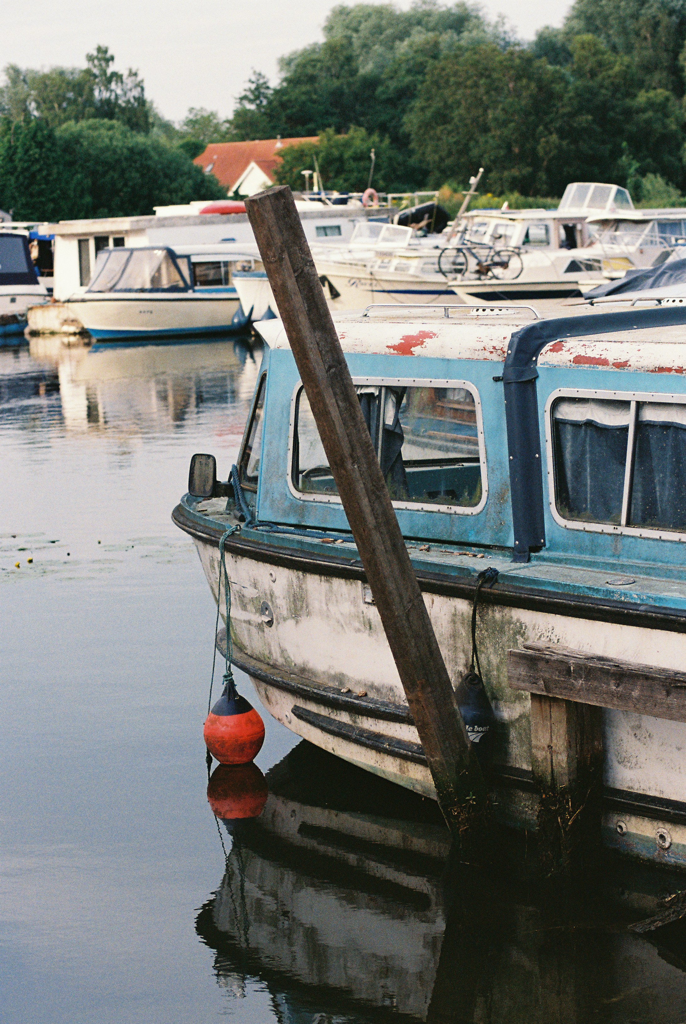 Rust and Ripples: A Docked Boat’s Weathered Quiet