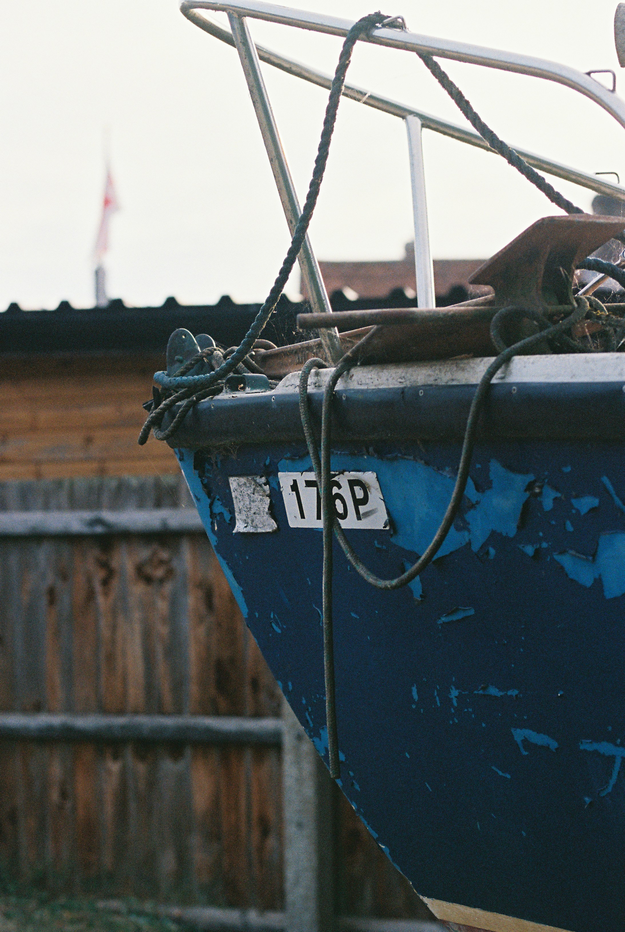 Blue Hull at Rest: A Weathered Boat by the Dock