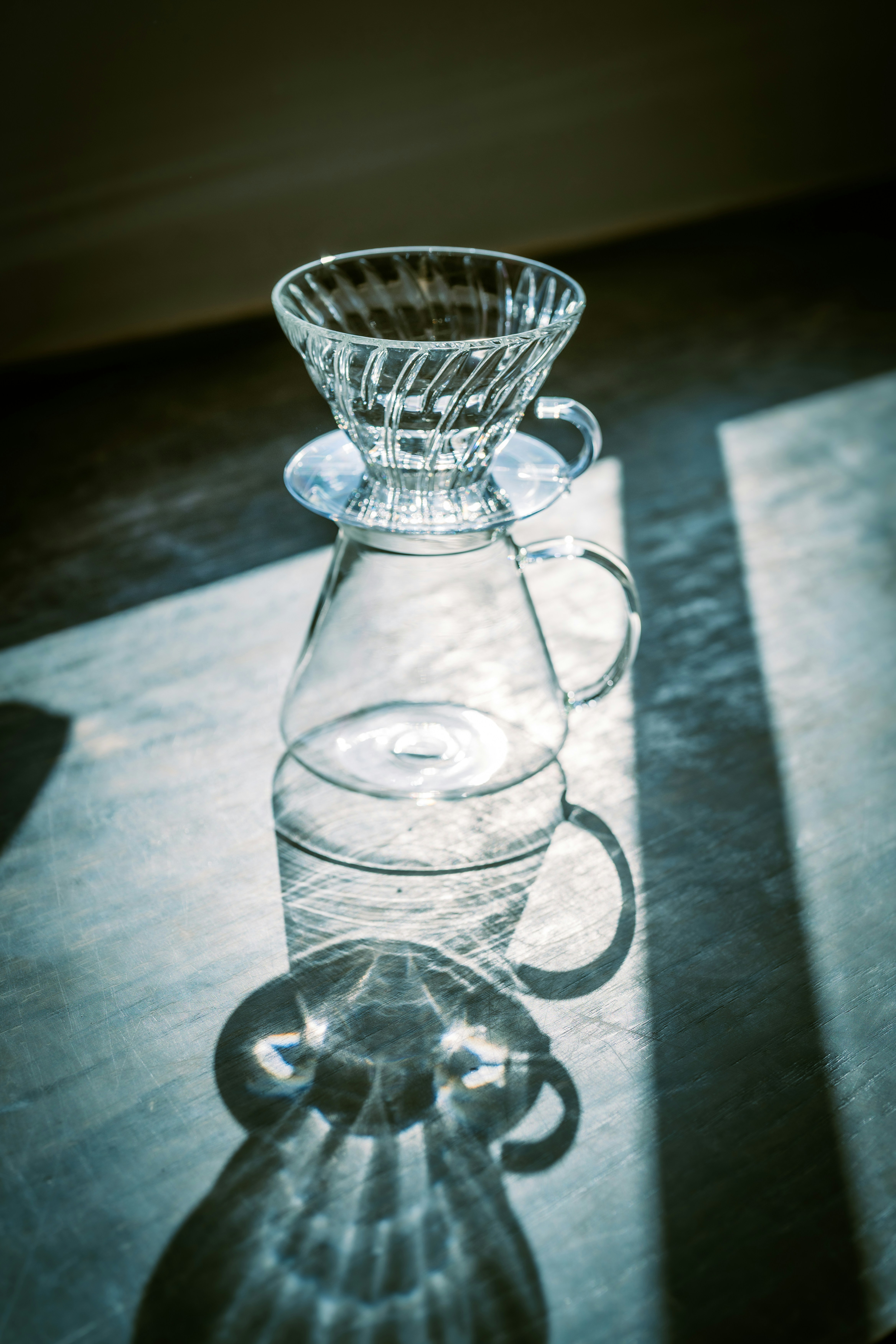 Reflected Geometry: Glass Carafe and Shadow Play