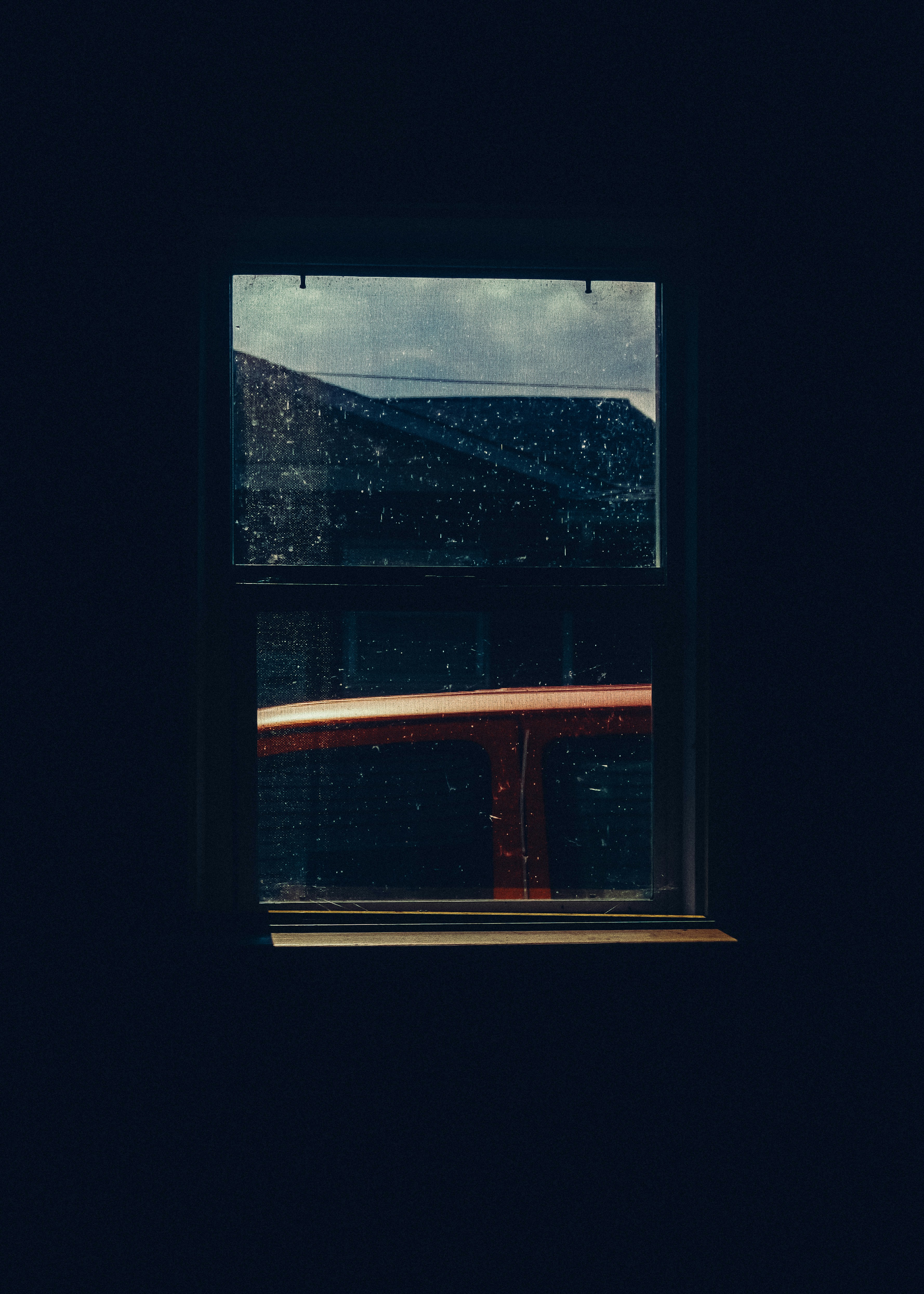 Rain-Streaked Window: A Quiet Glimpse of the Balcony