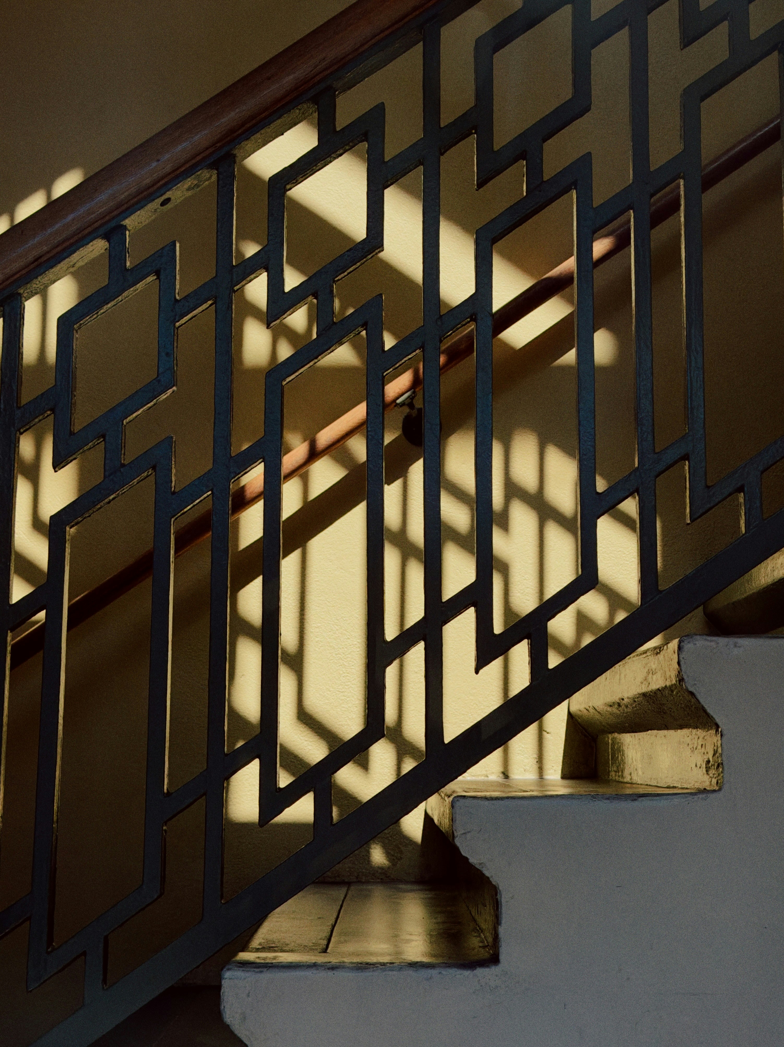 Geometric Shadows on a Staircase Railing
