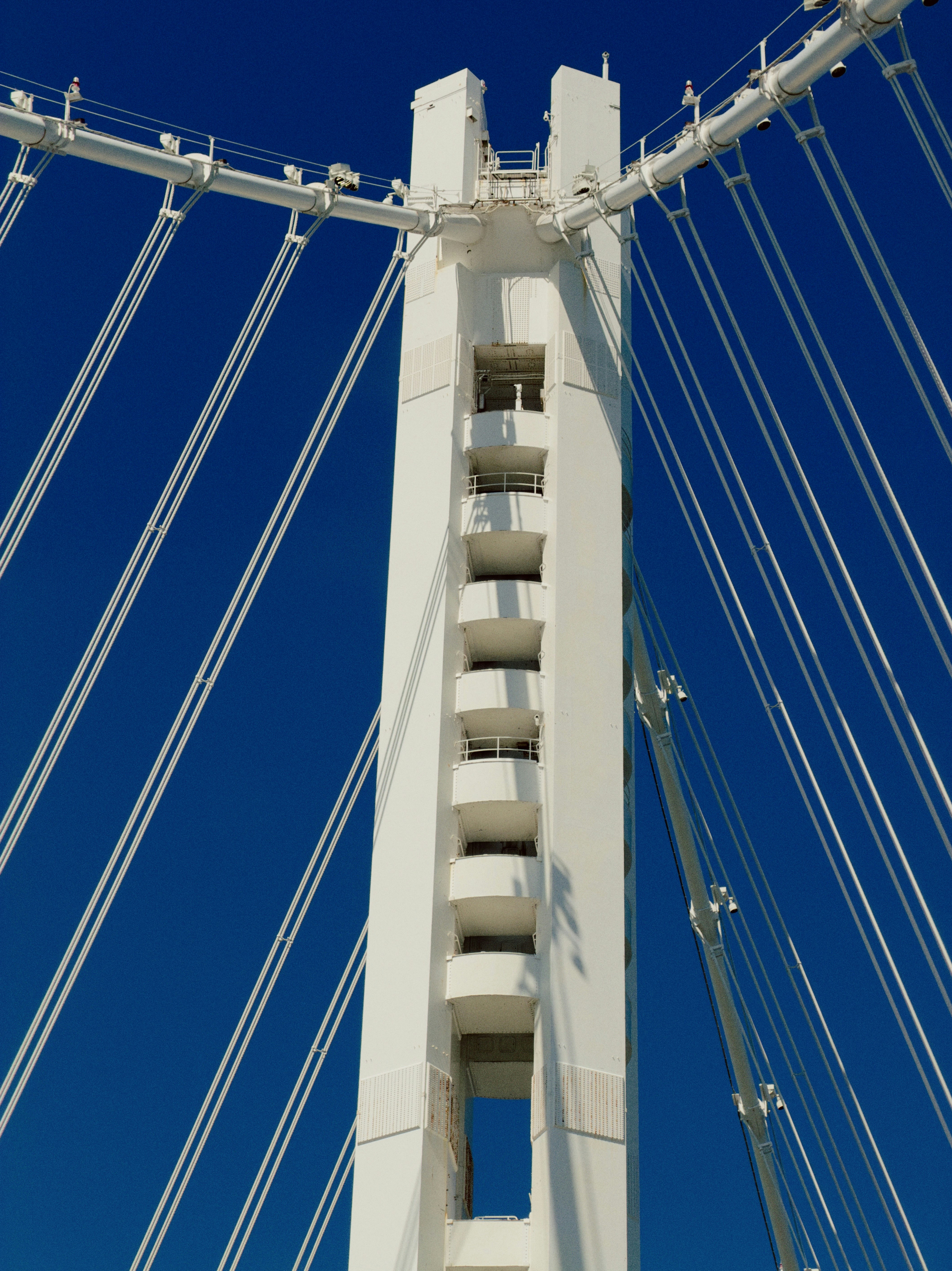 Skyward Spine: A Bridge Tower Against a Clear Blue