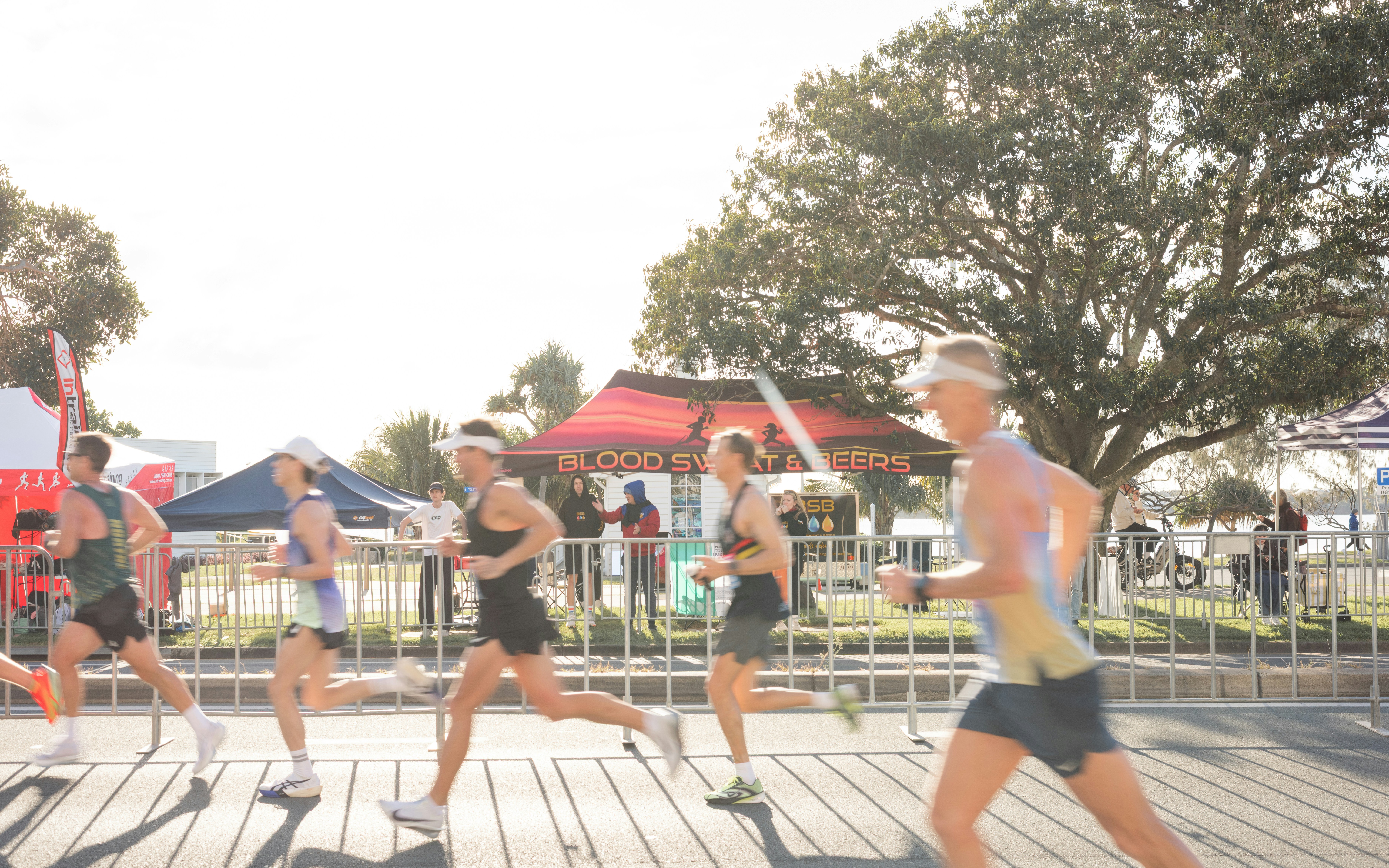 Mid-Race Momentum: A Stream of Runners Surges Forward on the Boardwalk