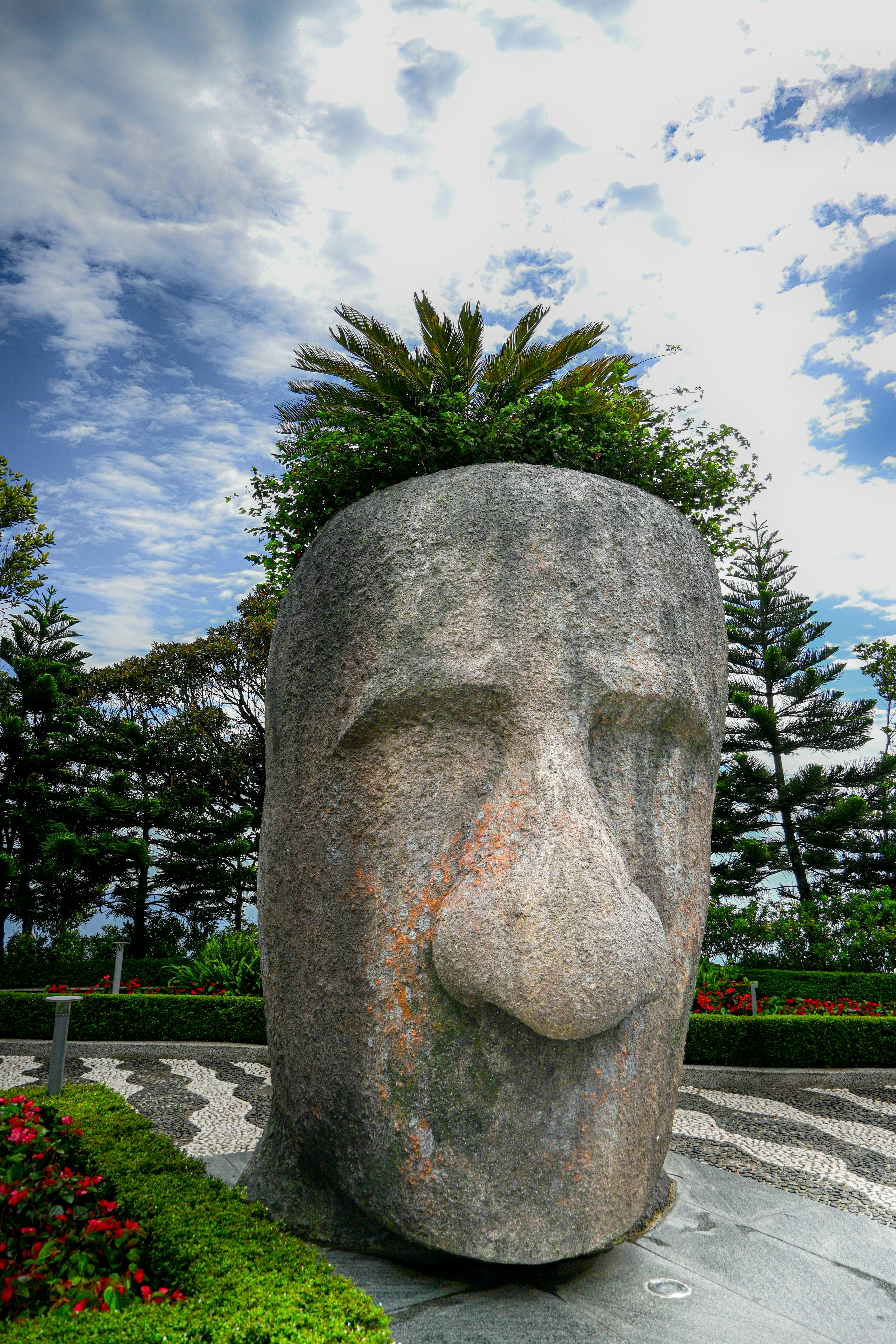 Stone Head in a Garden: Overgrown Crown and Serene Path