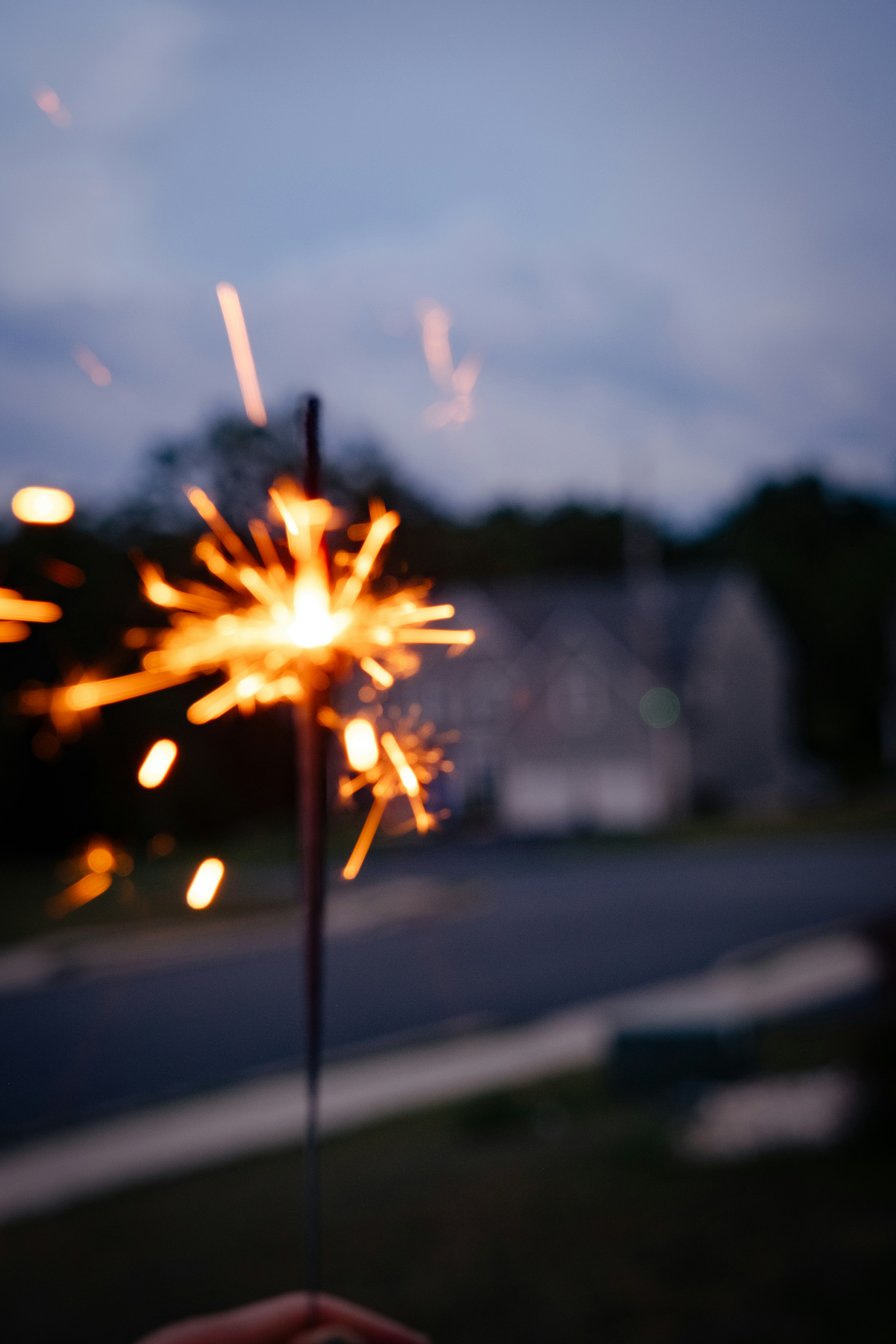 Spark on a Dusk Street: A Blurry Firework Stillness