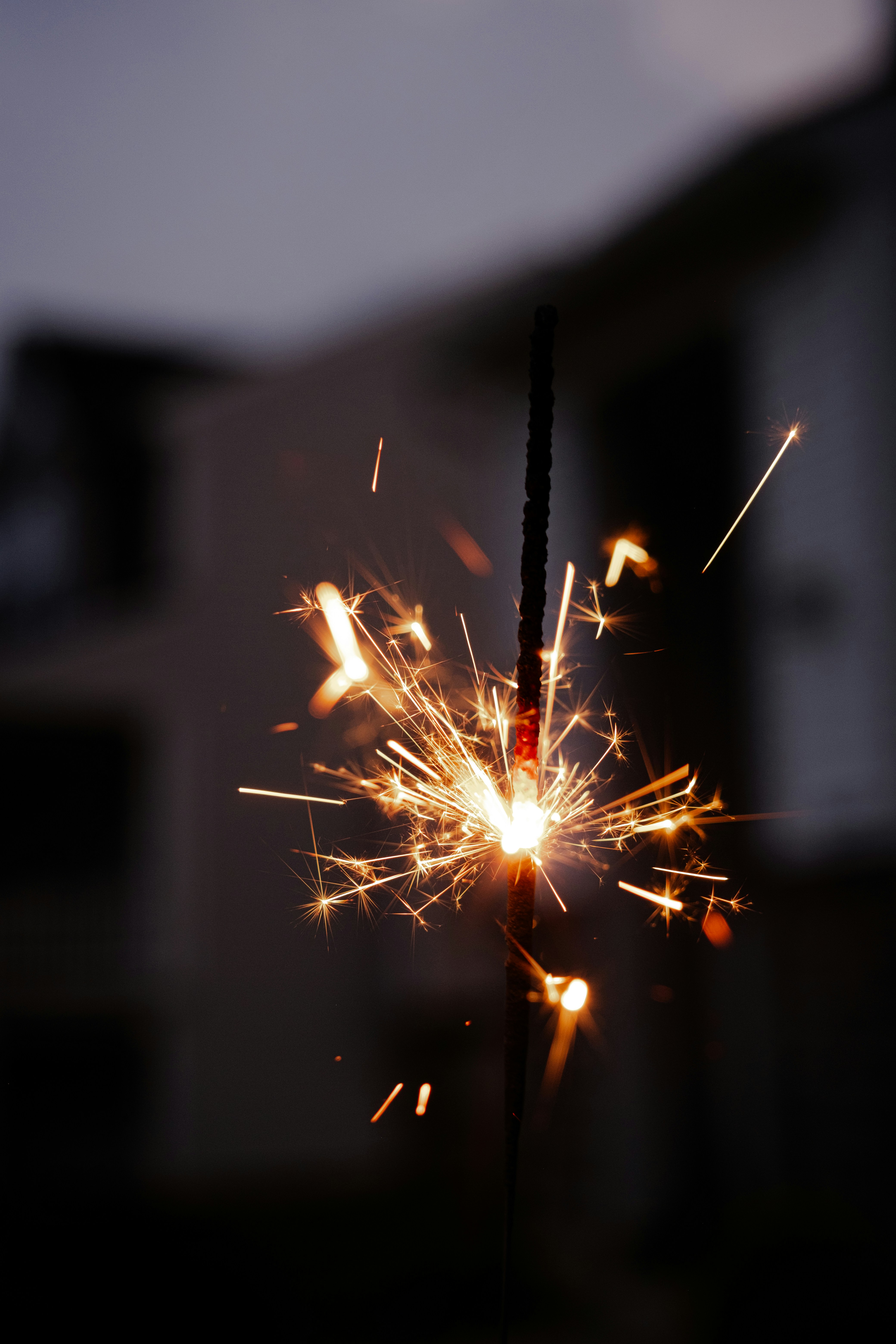 Spark of Night: A Close-Up of Firework Sparks Against a Darkened Backdrop