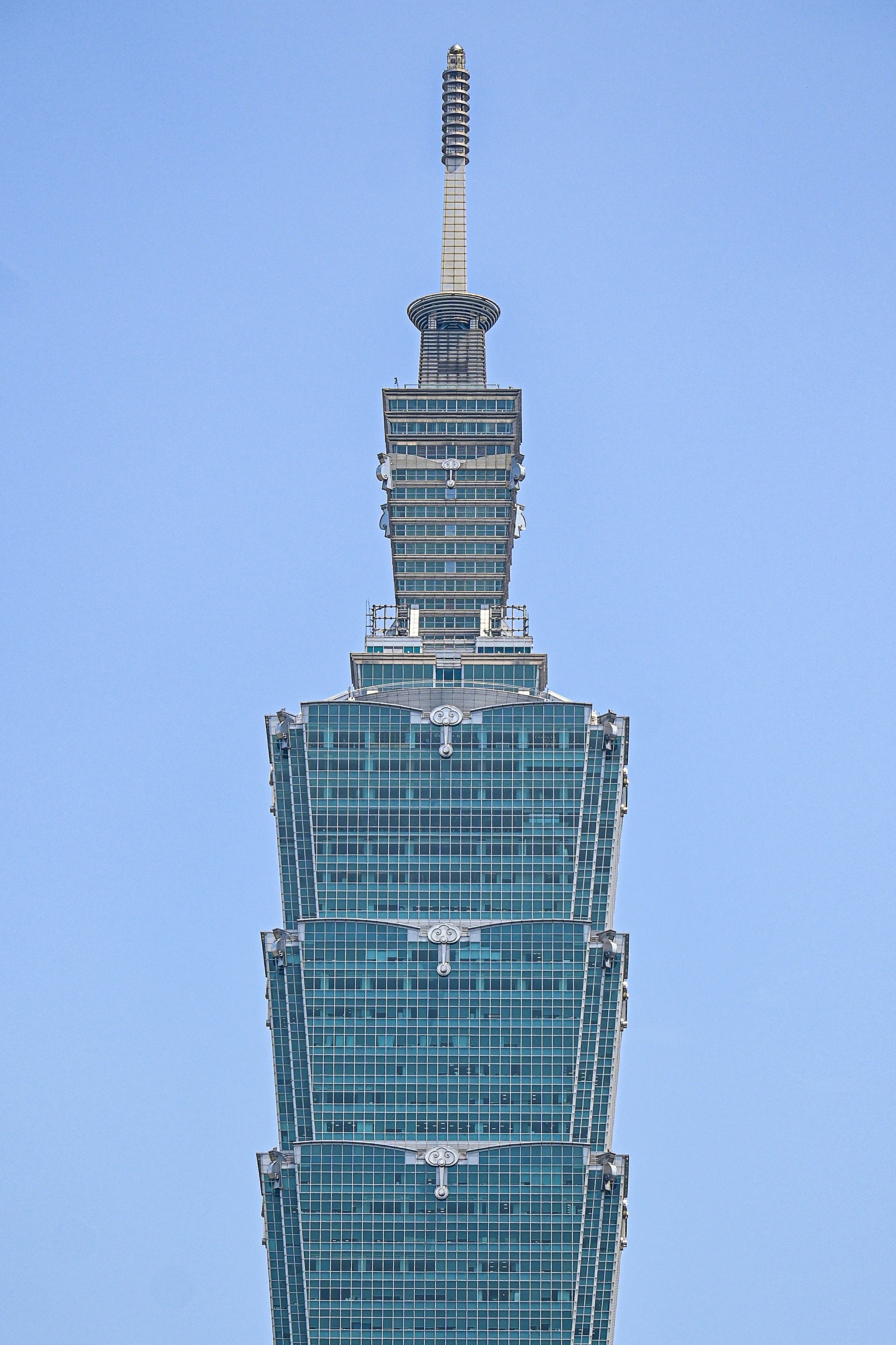 Taipei Tower in Sky: A Towering Symmetry Against a Clear Blue
