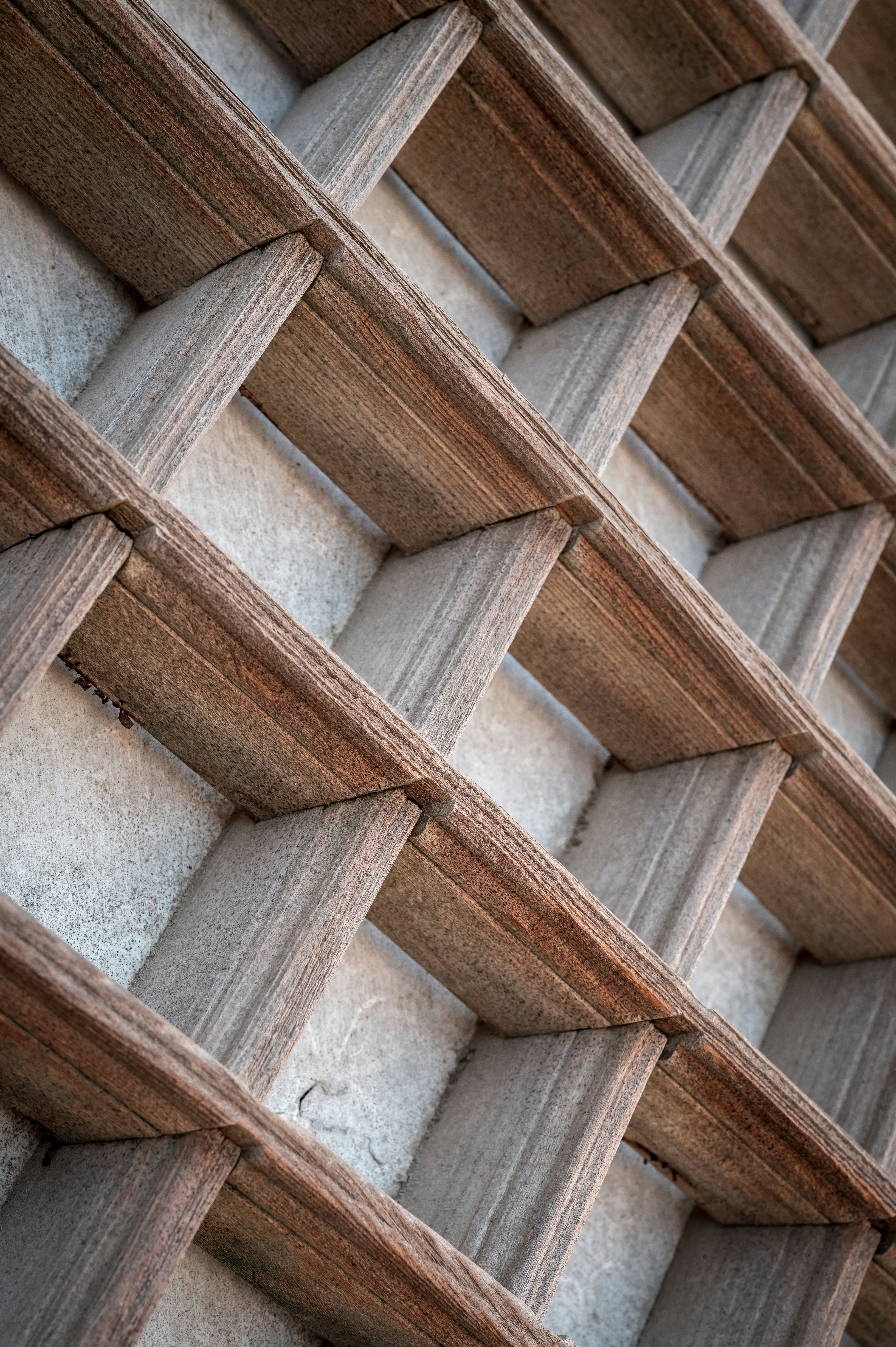 Geometric Tilts: Interwoven Clay Tiles in Sunlit Cadence