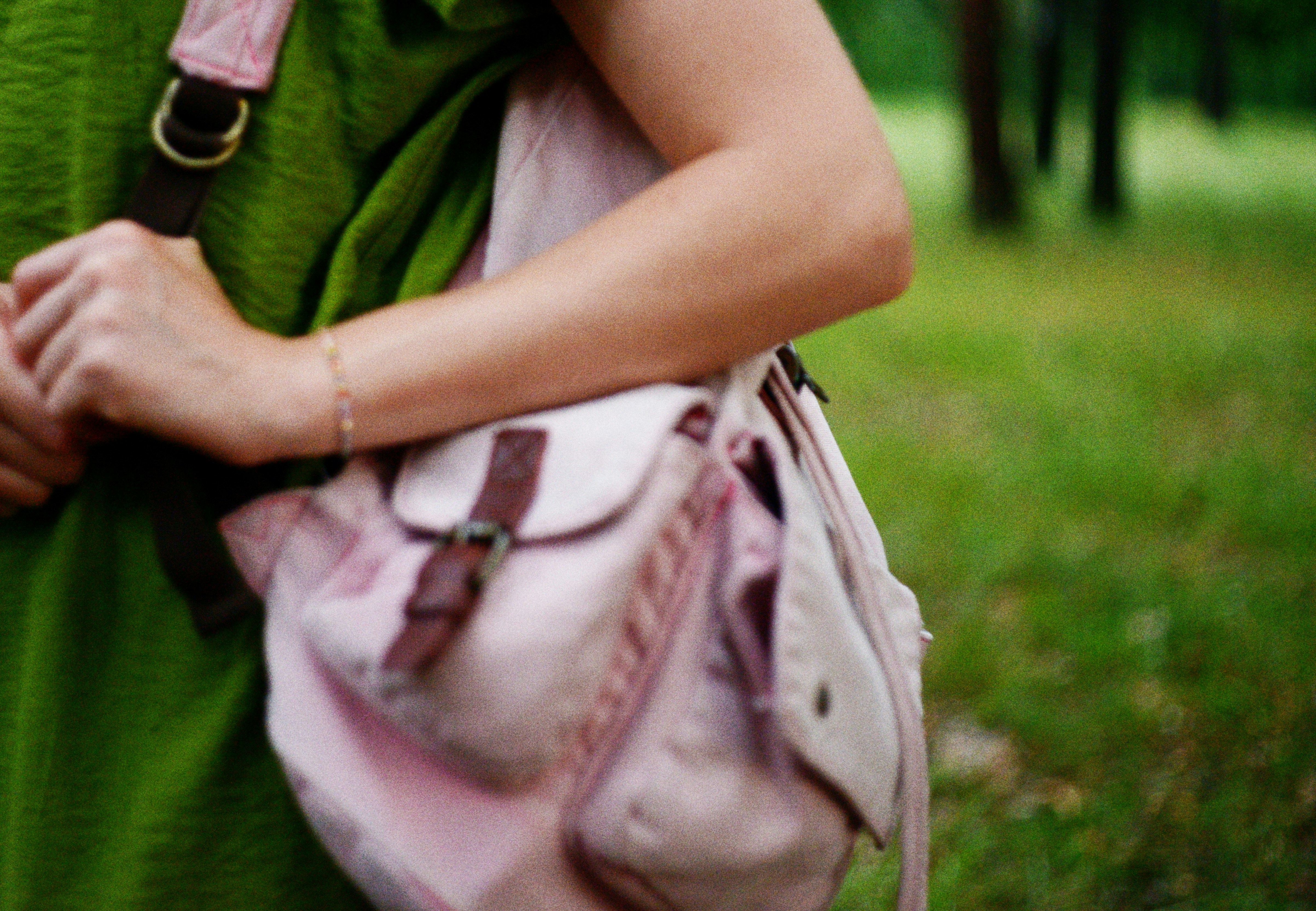 Soft-green Shoulder: A Pink Bag Amid Casual Movement