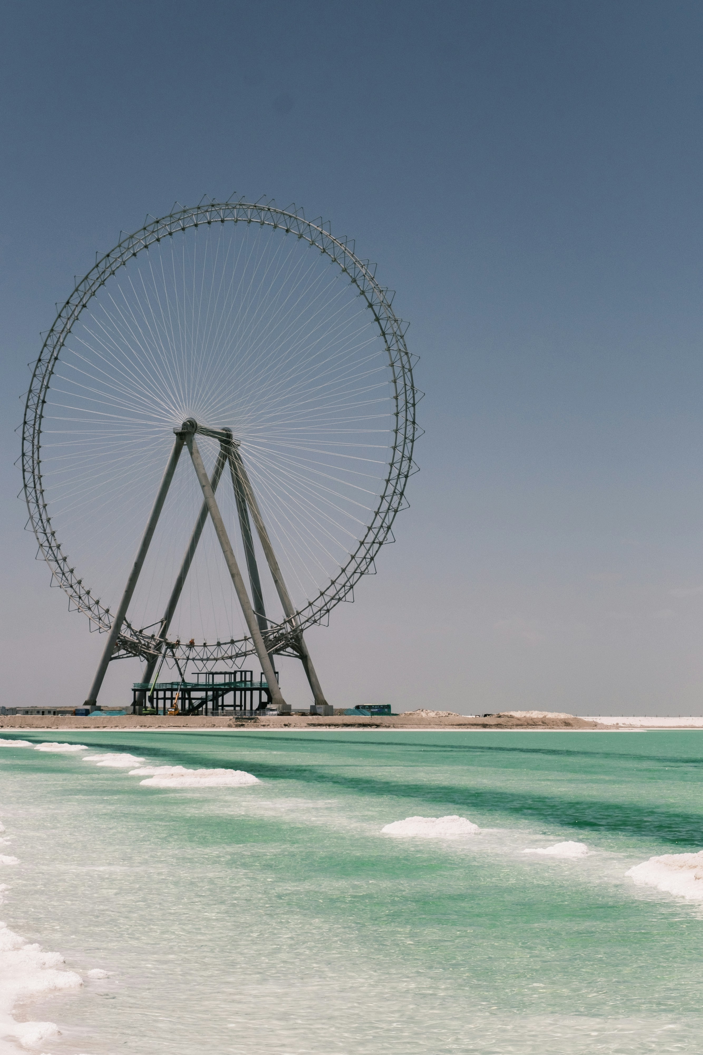 Giant Wheel Above Turquoise Waters at Dusk