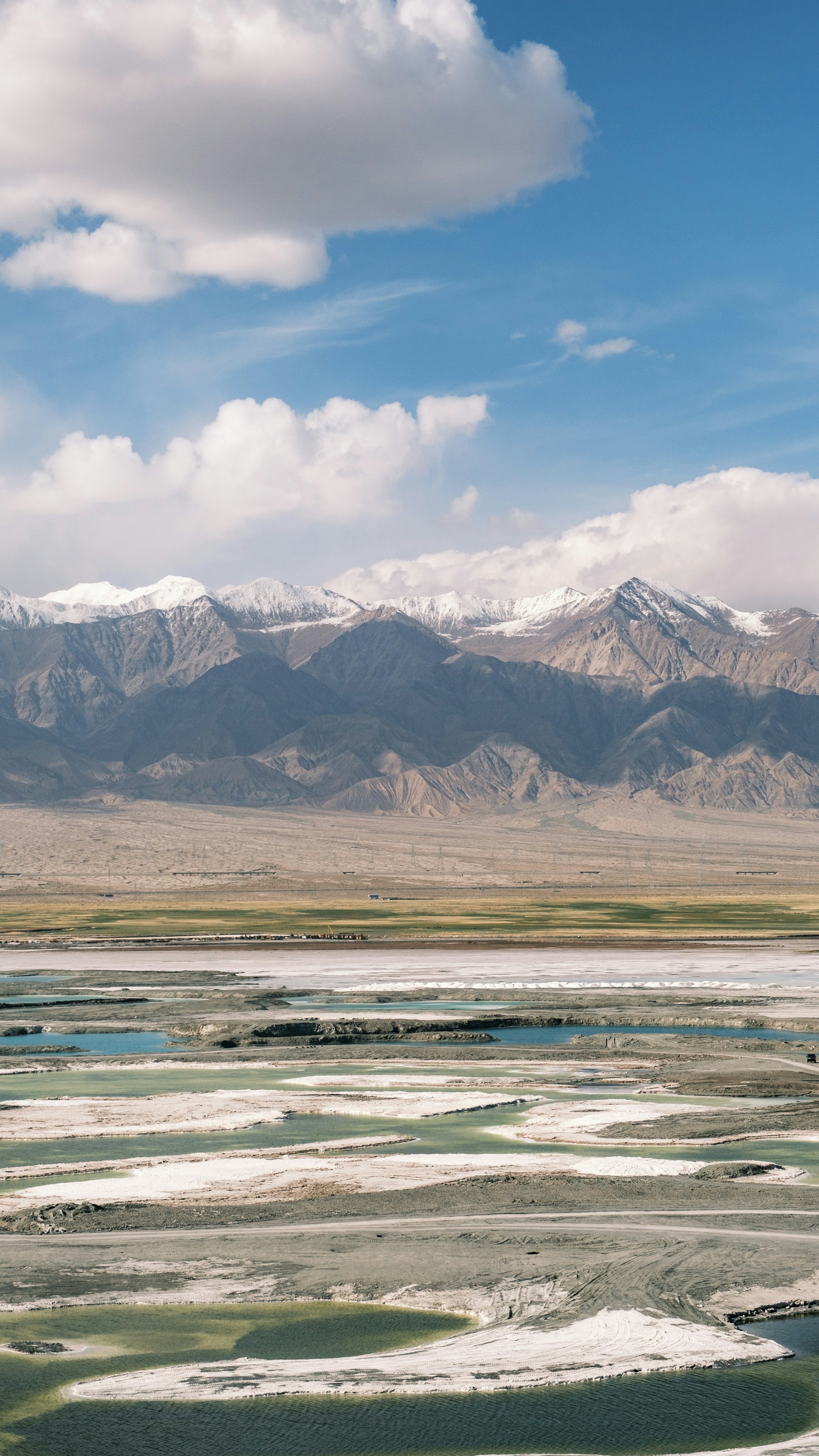 Desert Confluence: Snow-kissed Range Beneath Expansive Skies