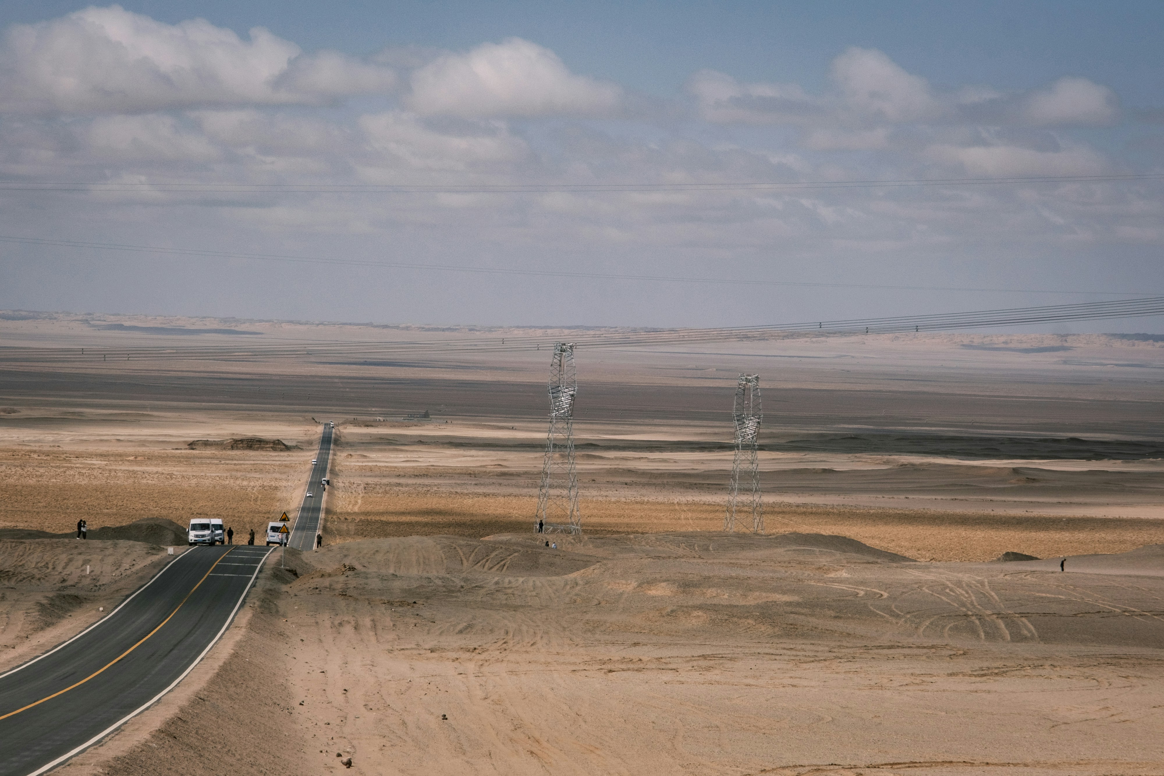Desert Highway Vanishing Toward Distant Towers