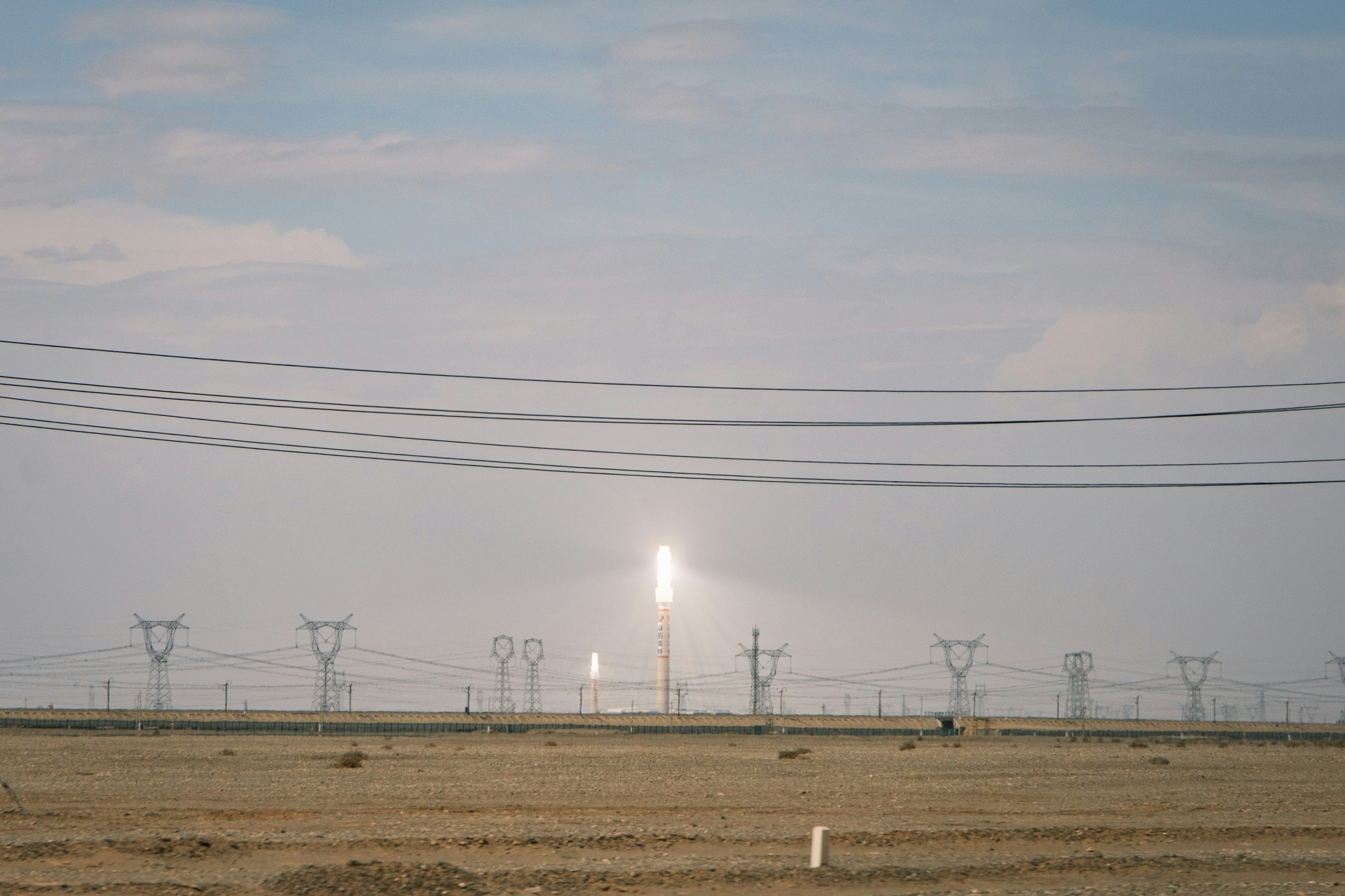 Launch Pad Quiet in a Desert: The Nightly Long Arc of Transmission Towers