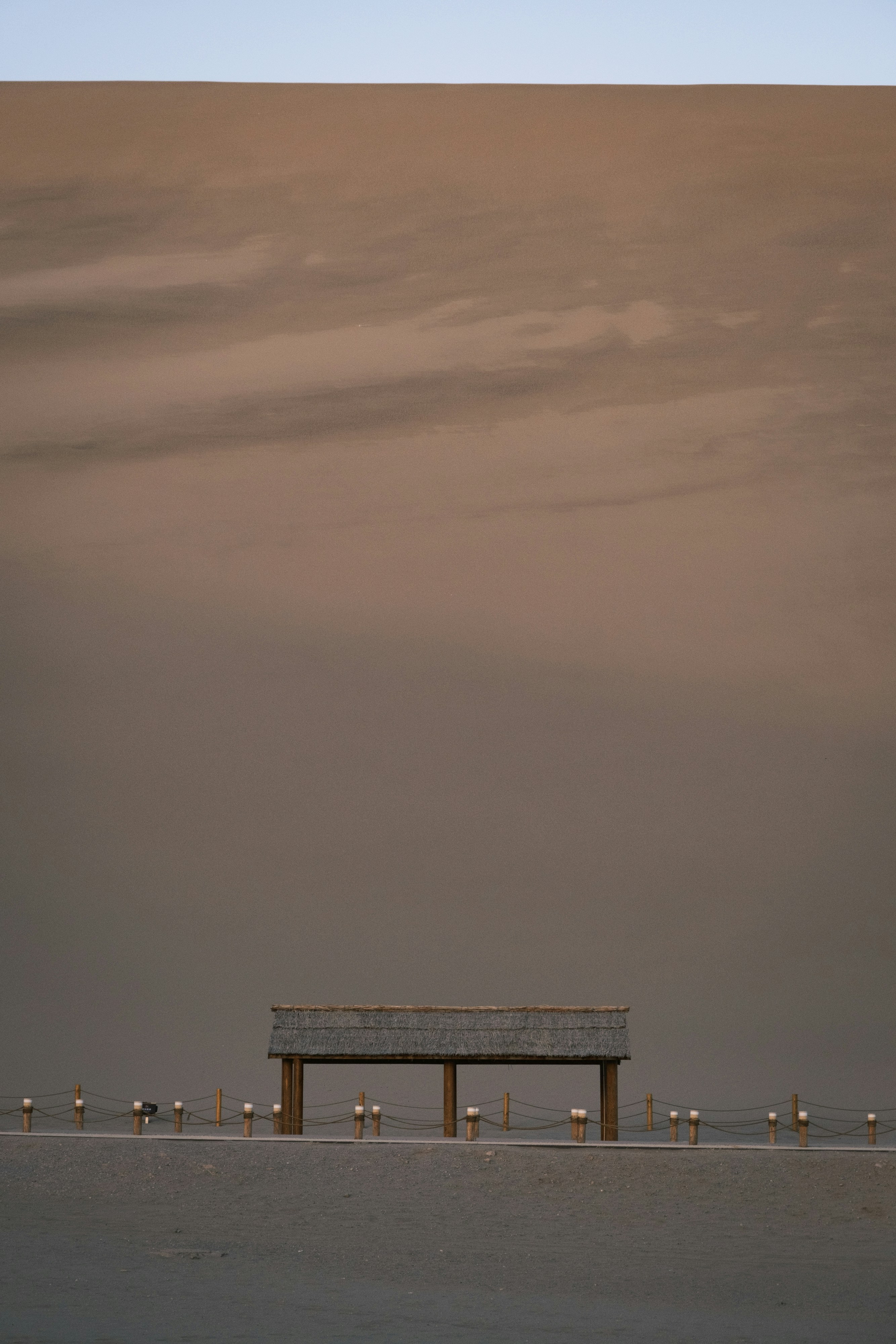 Deserted Boardwalk Pier Against Pale Skies