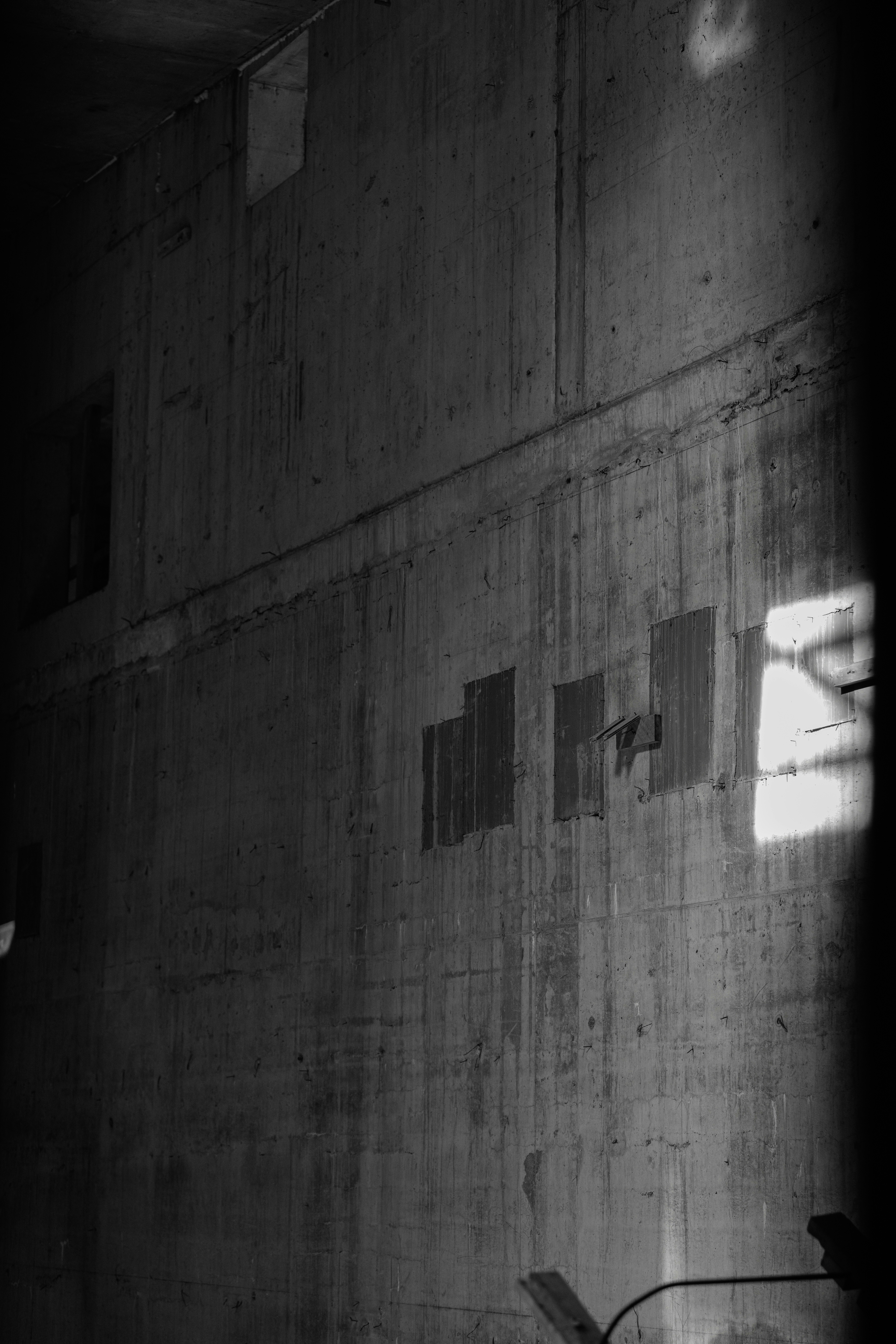Shadowed Concrete: A Narrow Corridor of Light