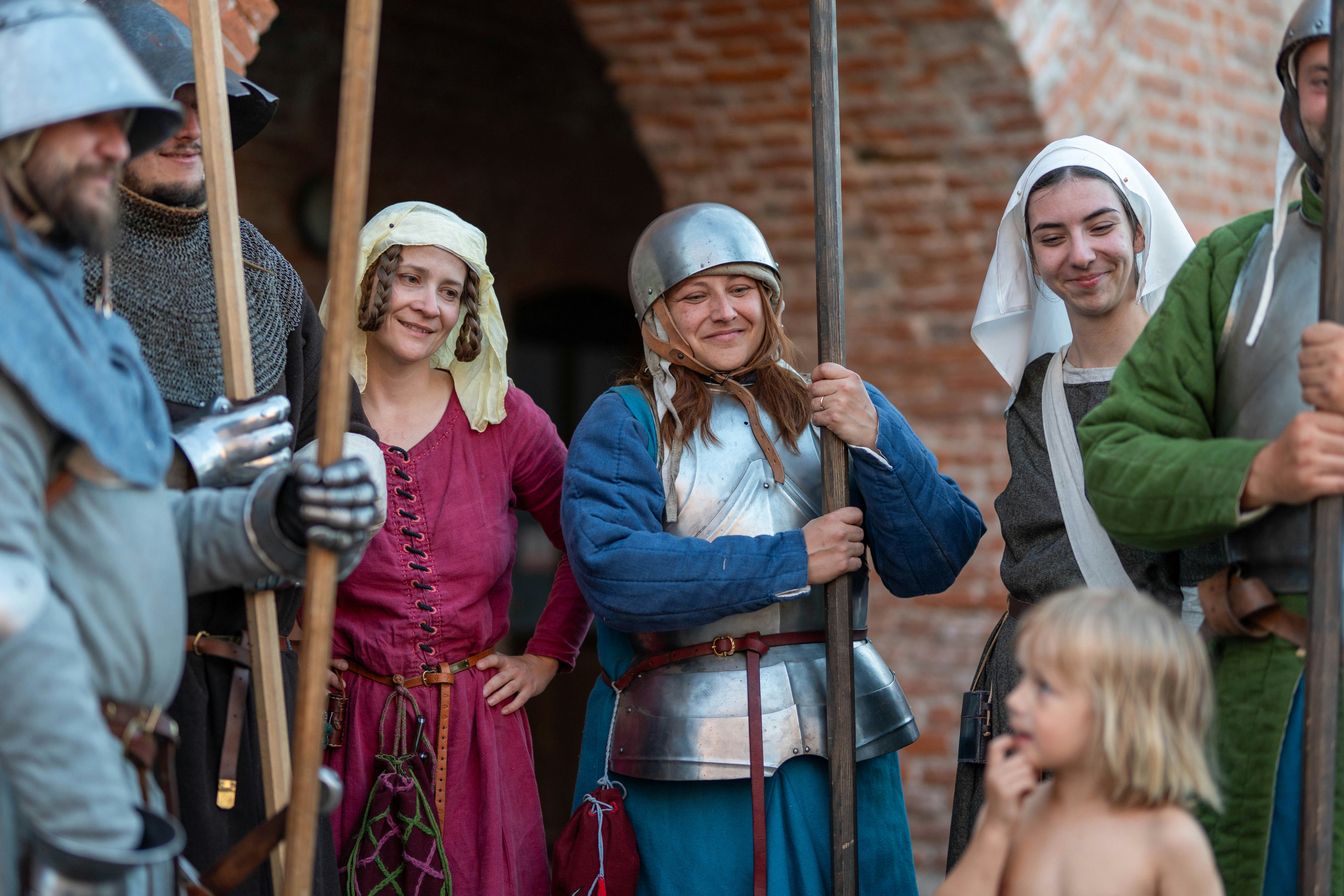 Medieval assemble: a cheerful group of costumed reenactors in the courtyard