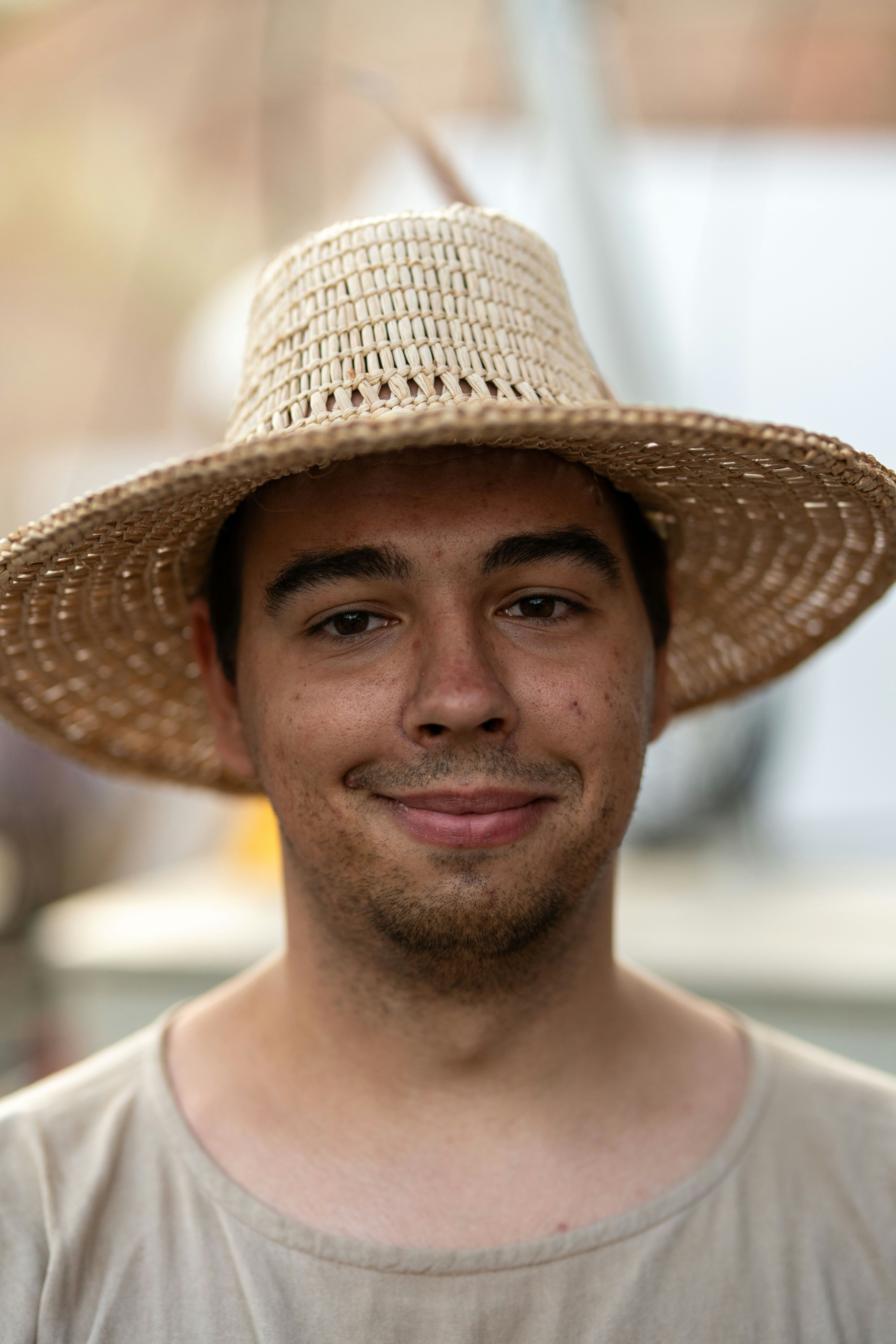 Warm Horizon: A Sunlit Portrait in a Straw Hat