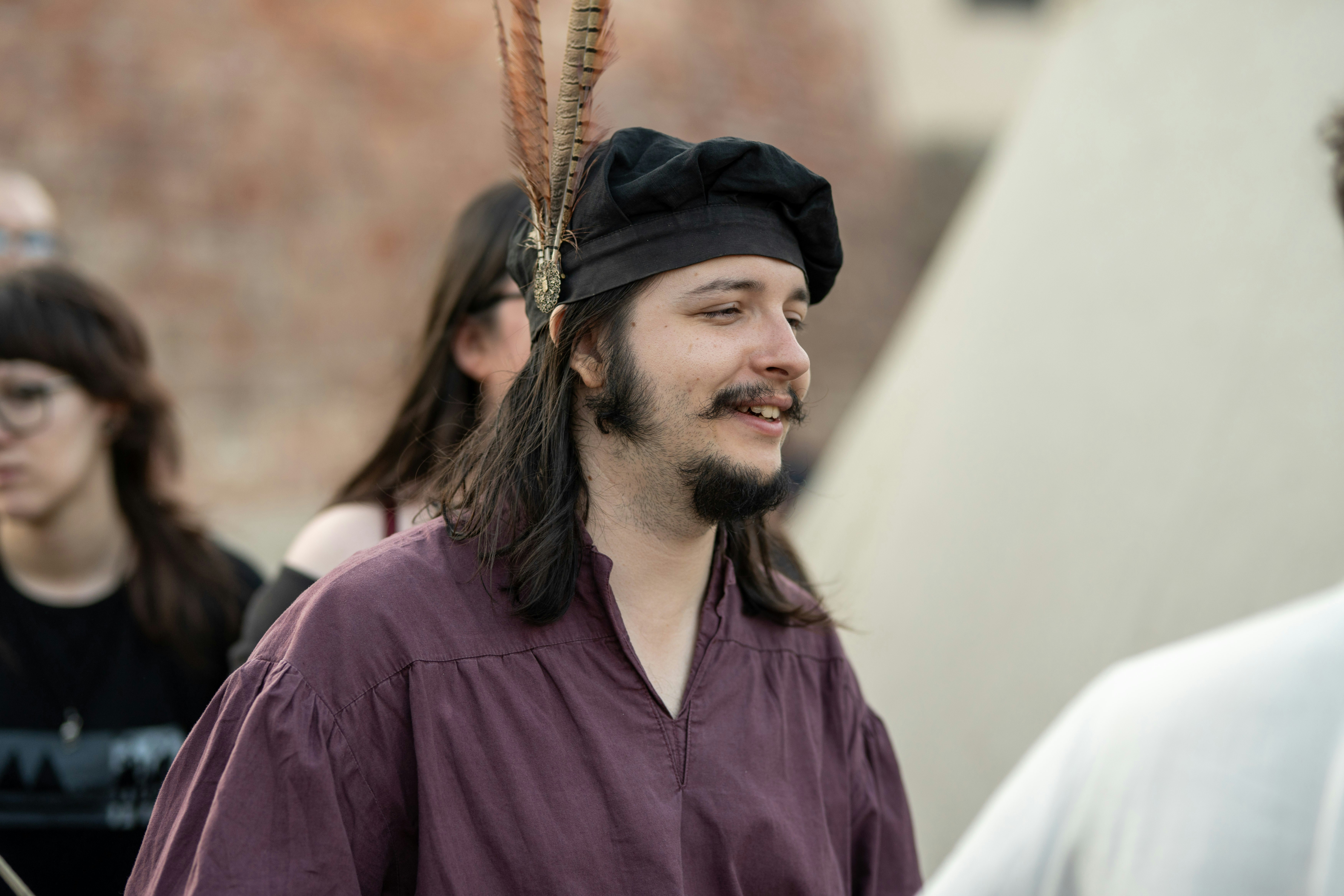 Feathered Attire and Calm Gaze at a Distant Event