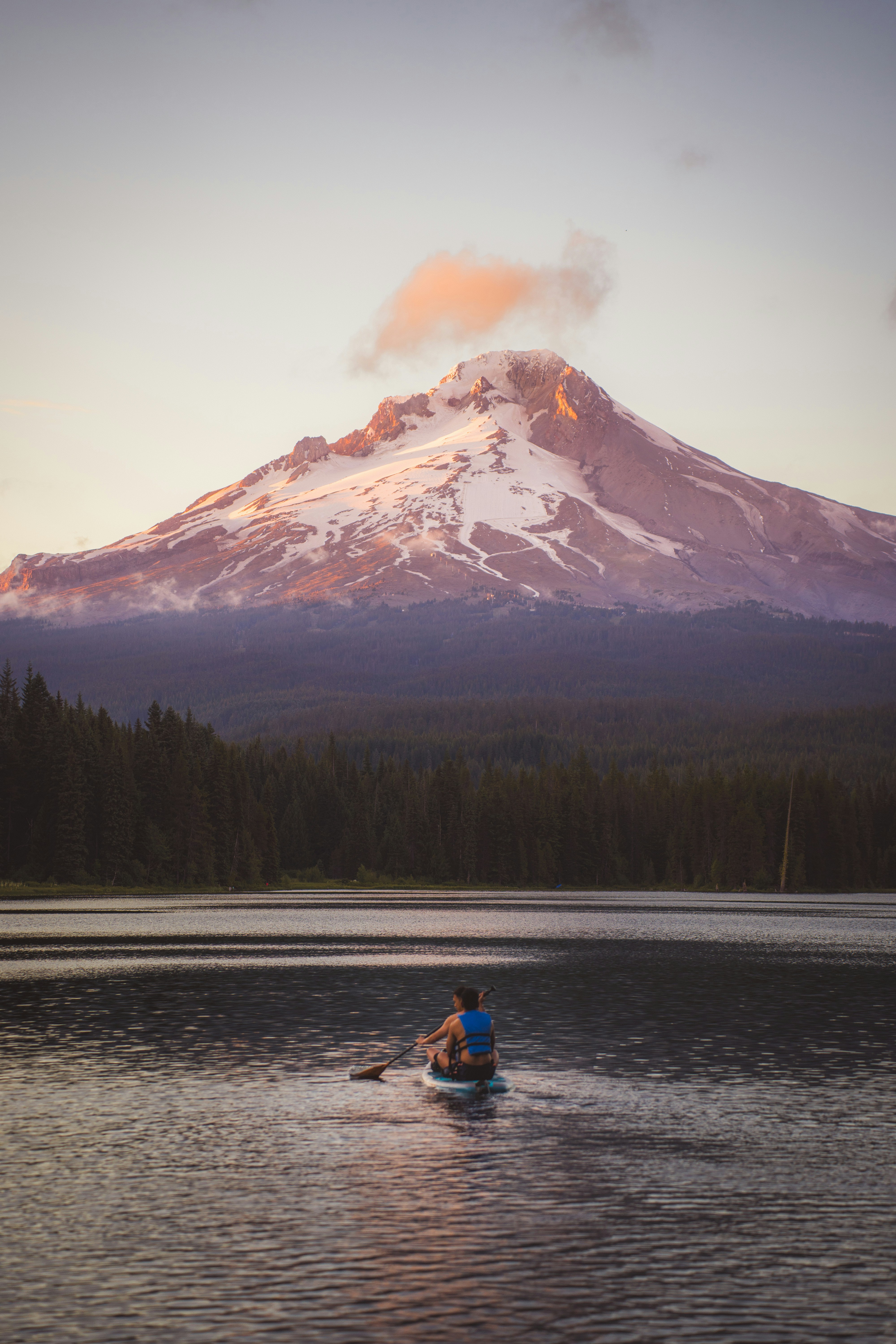 Mountaintop Solace: a lone kayaker before a towering peak
