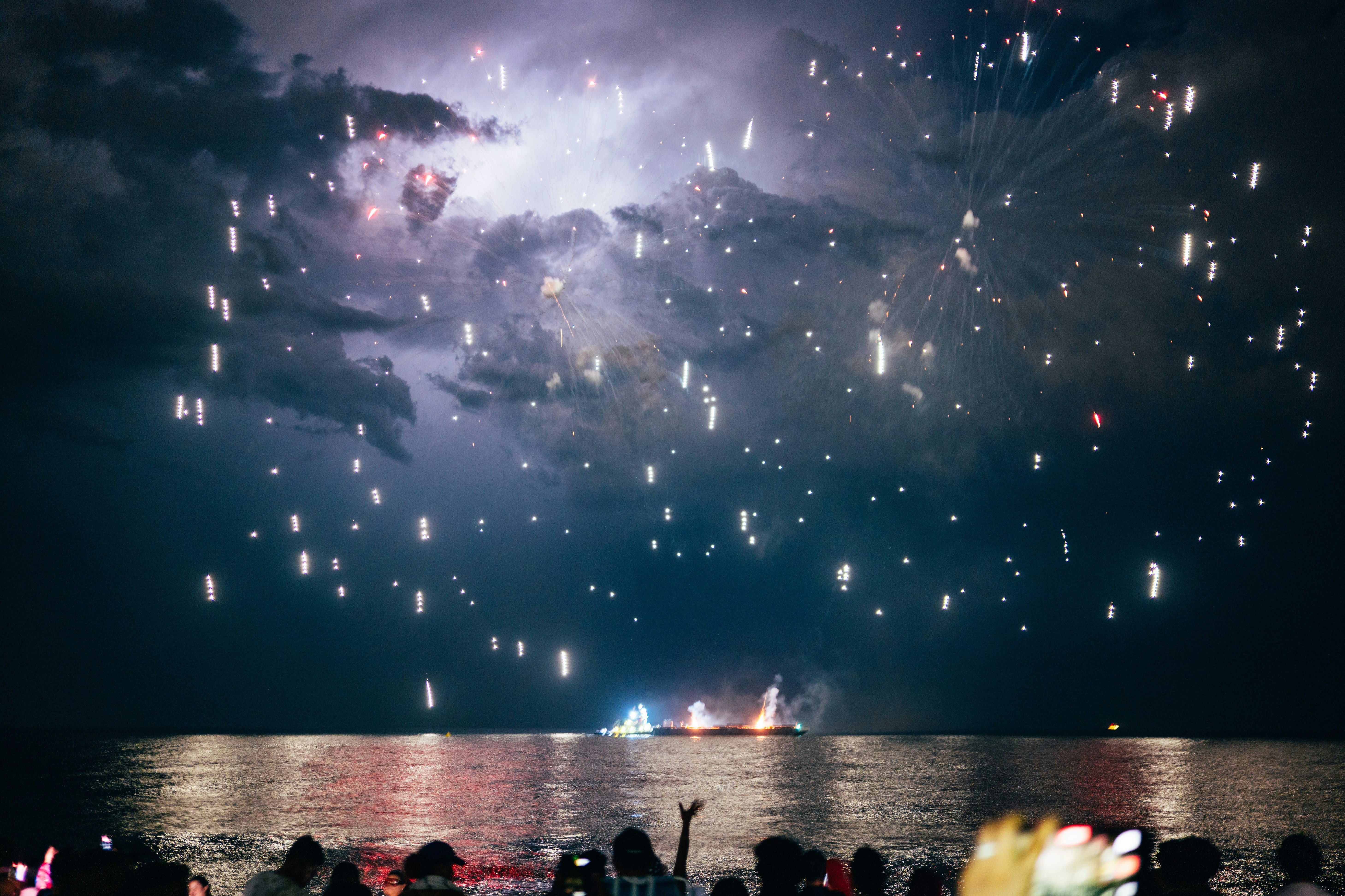 Midnight Fireworks over a Distant Sea