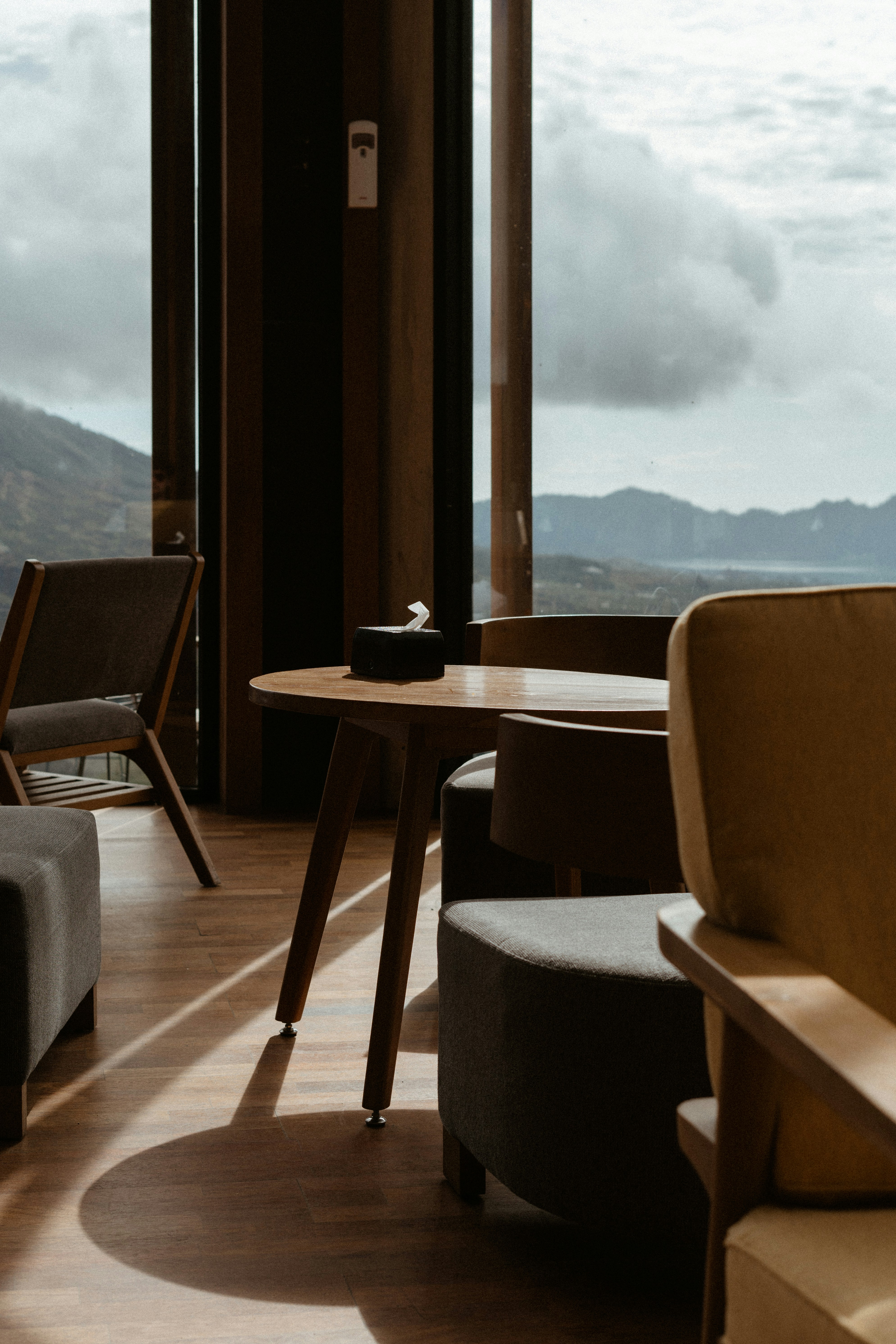 Ambient Teal Lounge: Sunlit Tables and Scenic Windows