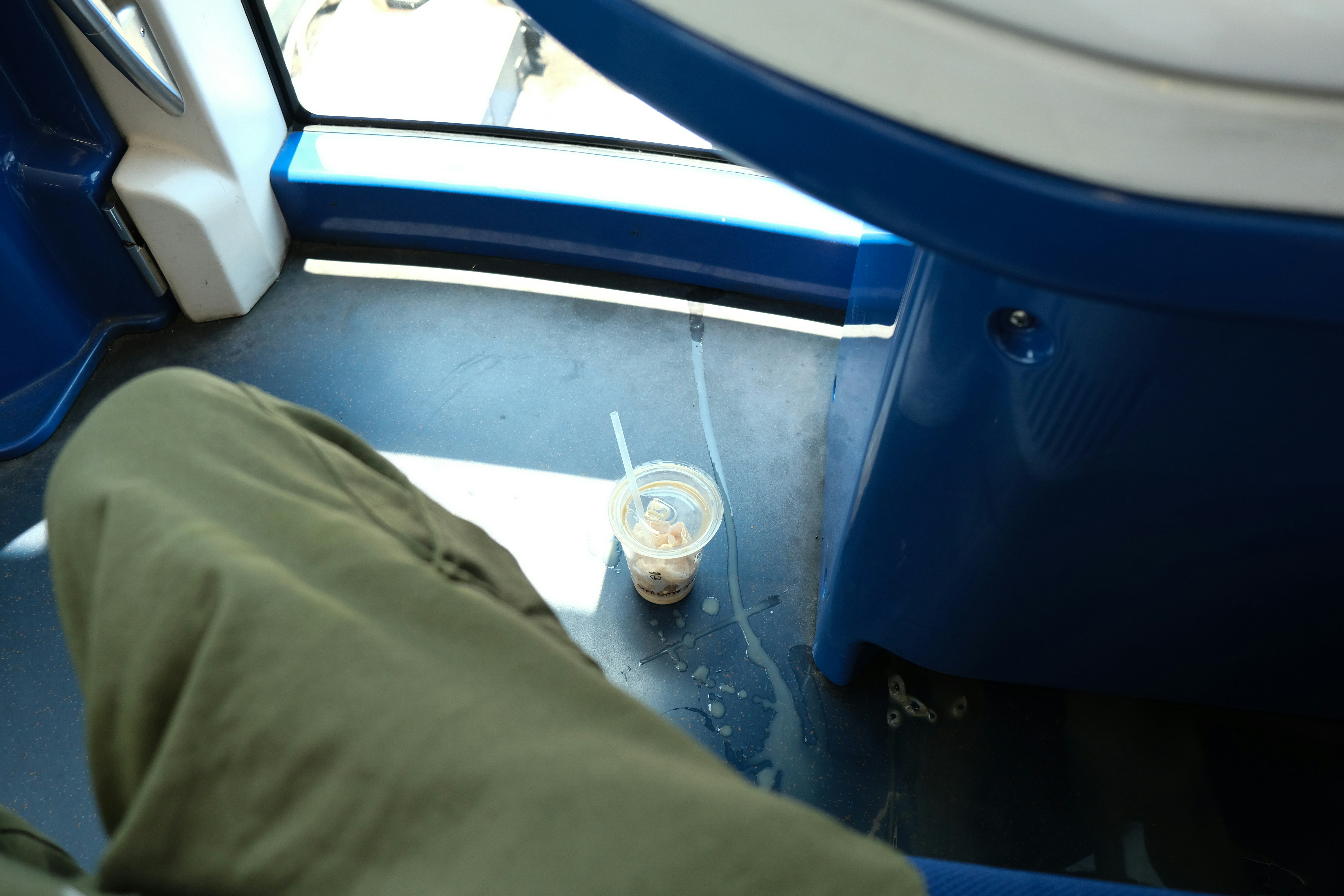 Seat View with Drink Break: A Quiet Moment inside the Bus