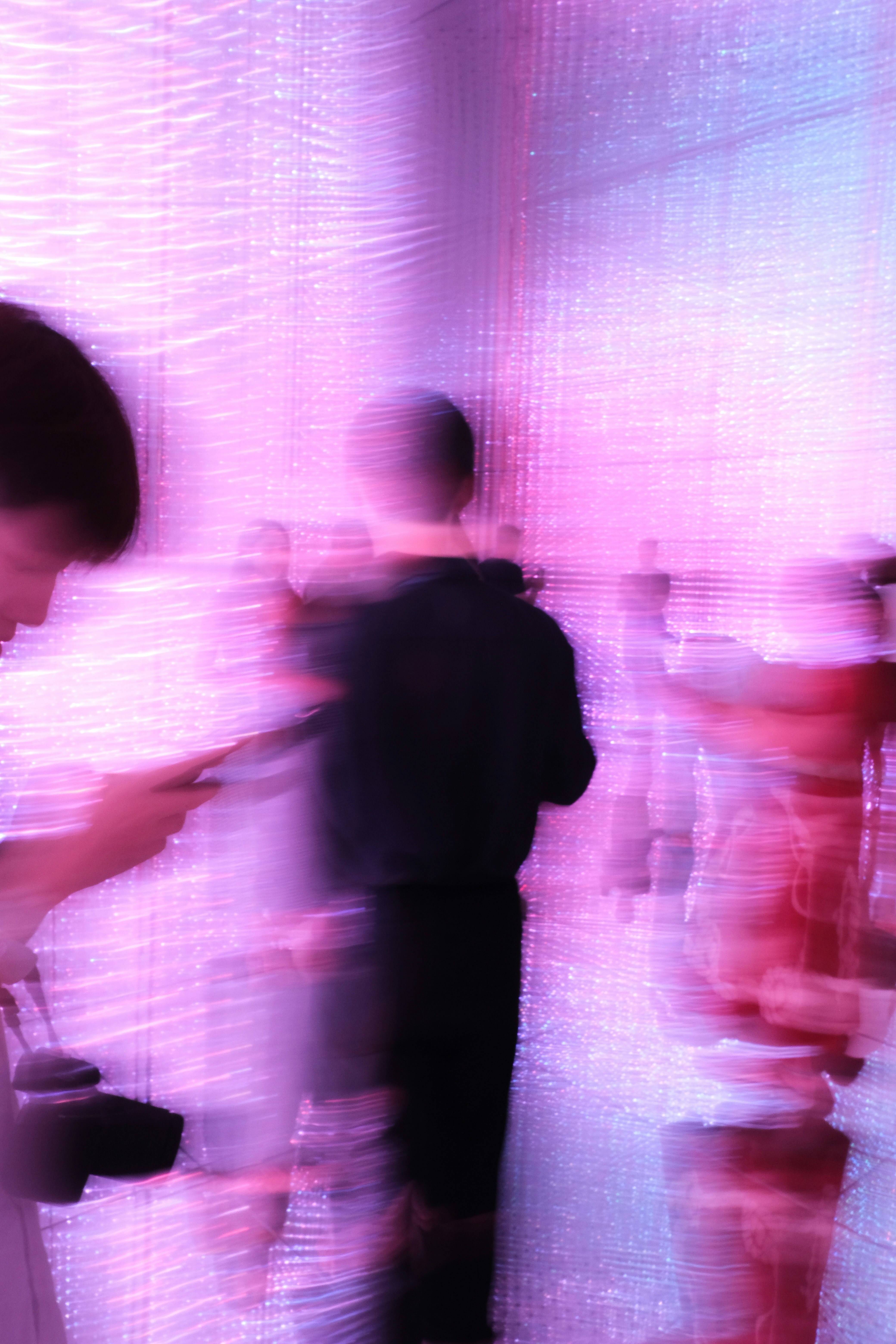Center of Neon Blur: A Passerby in Violet Light