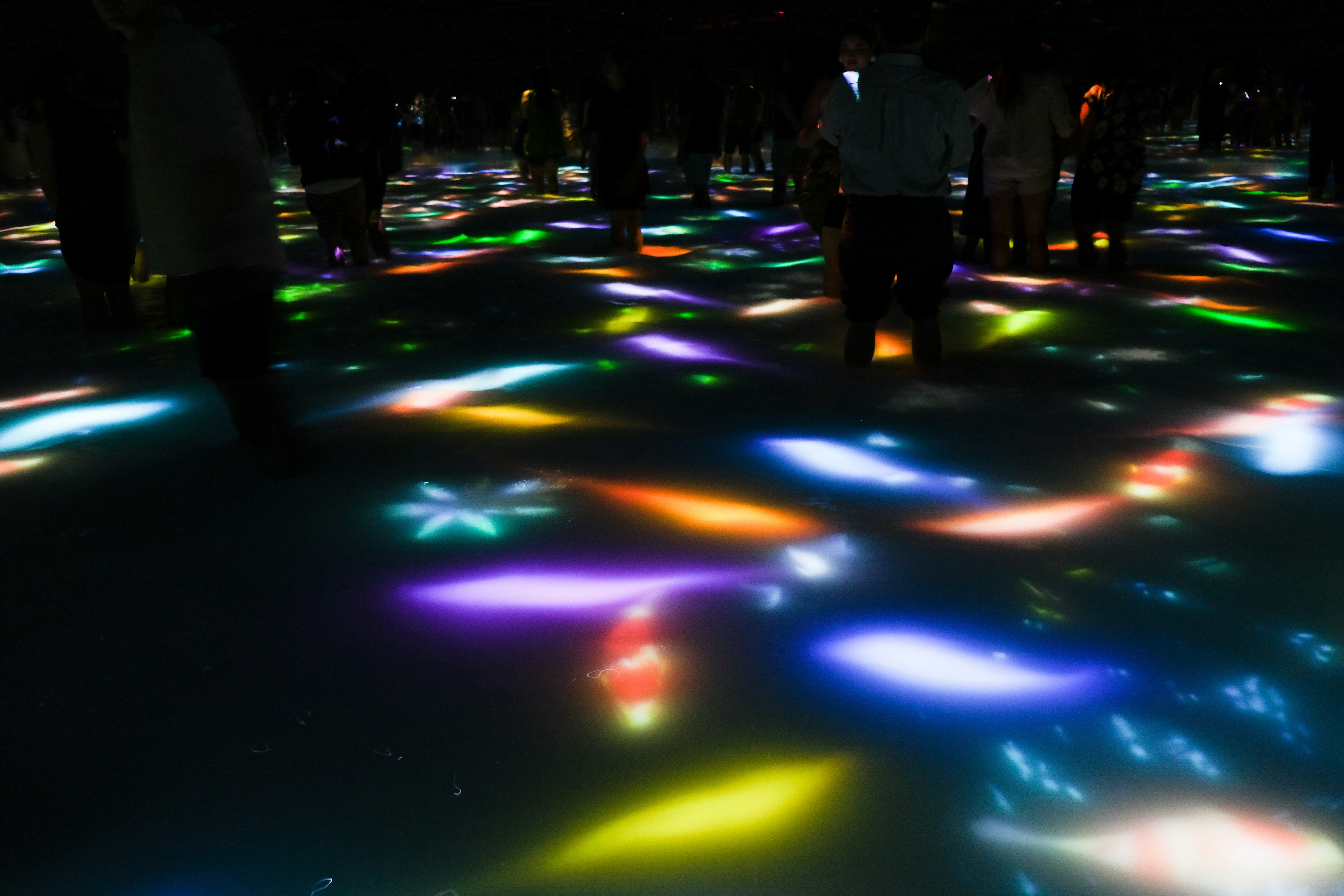 Chromatic Footpath: People Walk the Lighted Floor