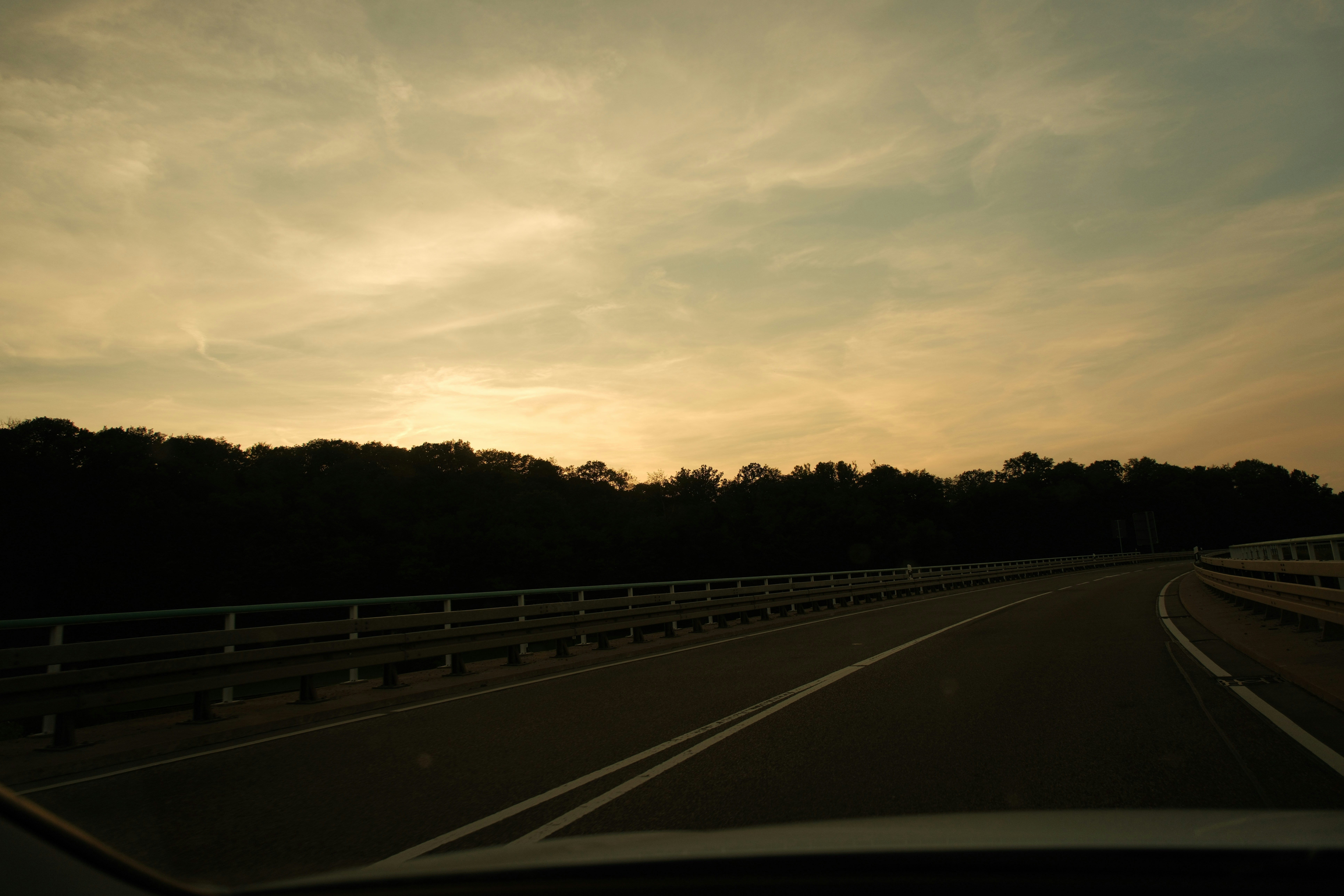 Dusk Drive: Edge of Sunset on an Open Bridge