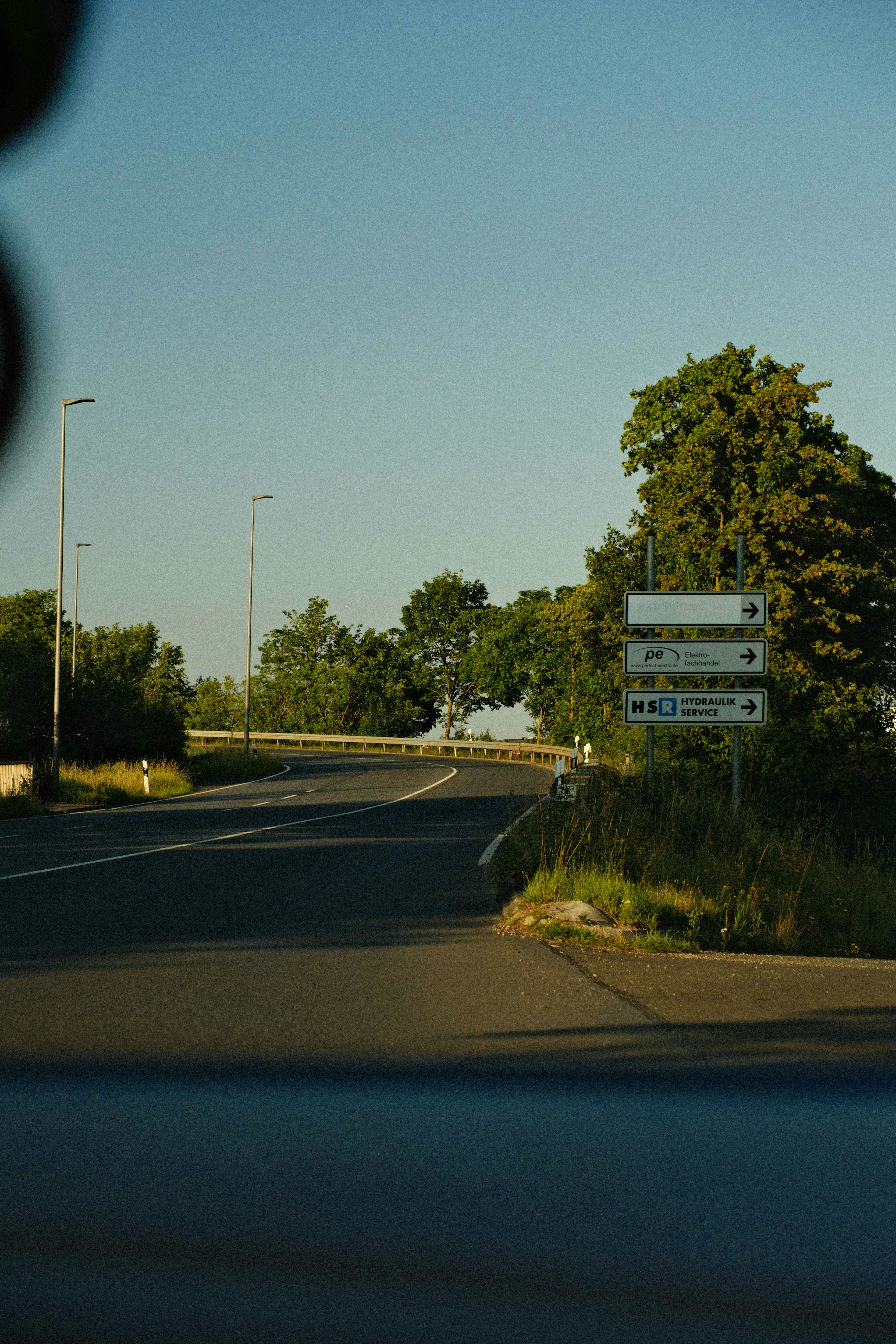 Rural Road Signage at Dusk: A Quiet Drive Into the Suburbs