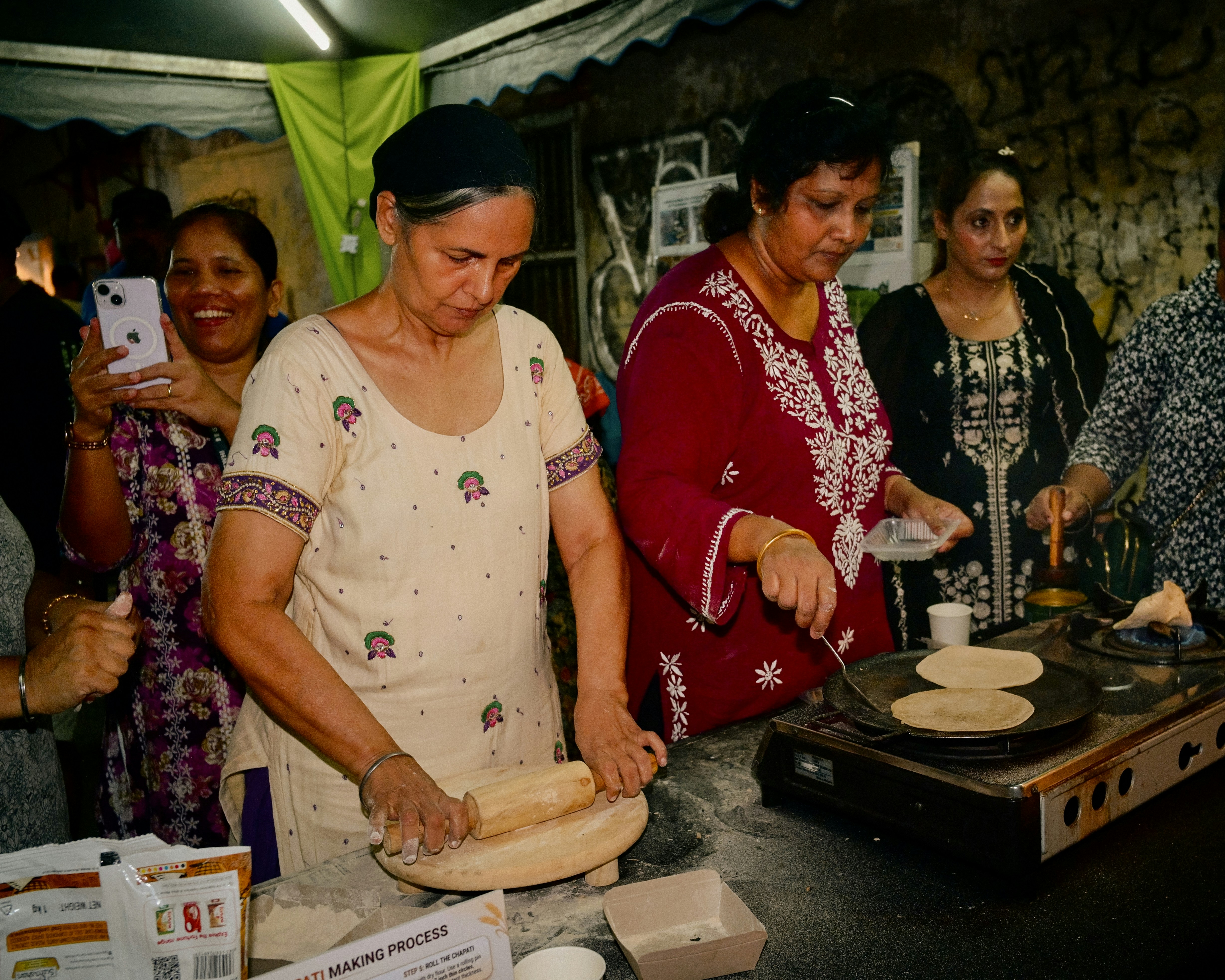 Hands at Work: Rolling Dough in a Bustling Indian Kitchen