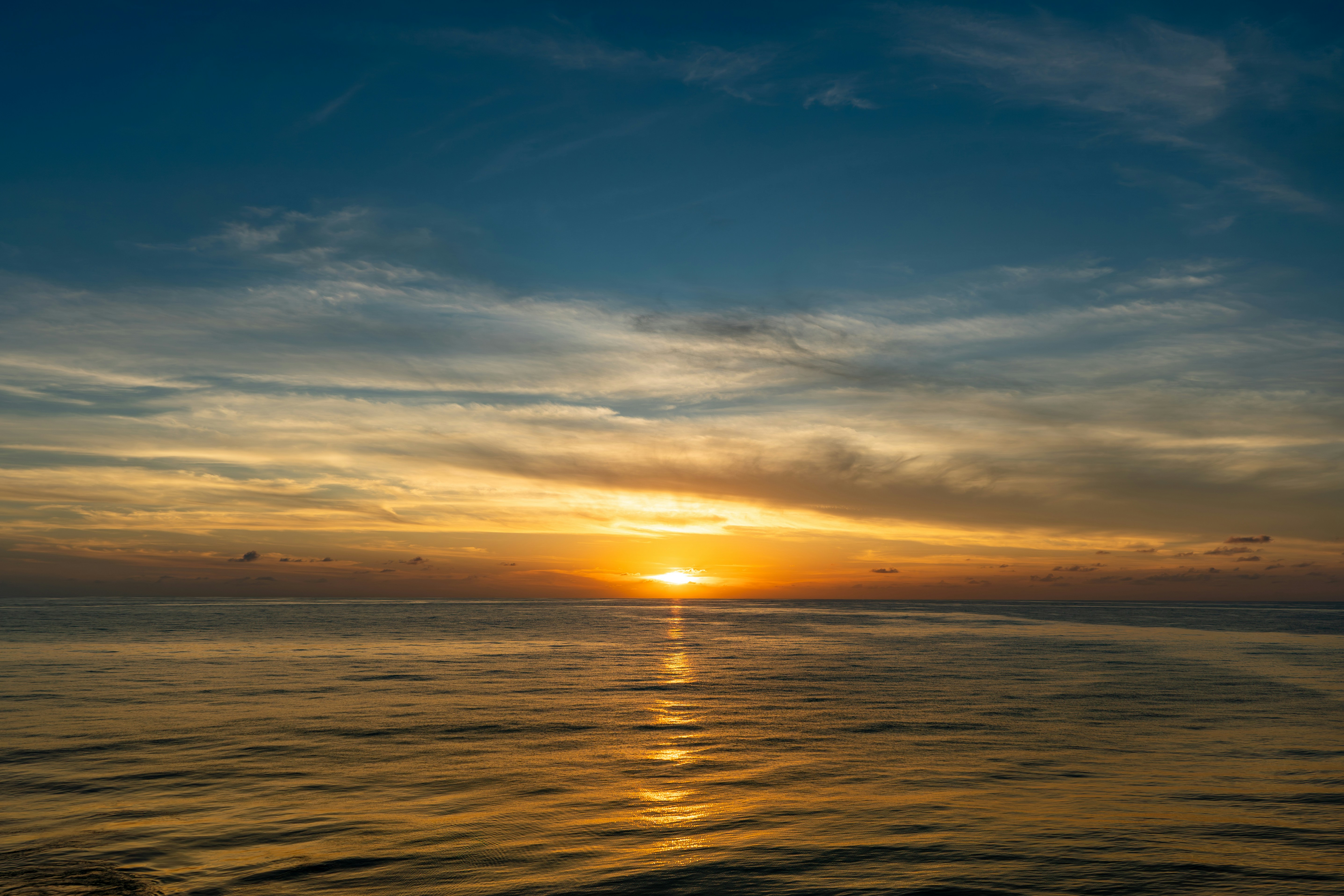 Sunlit Horizon: A Quiet Sea at Dusk