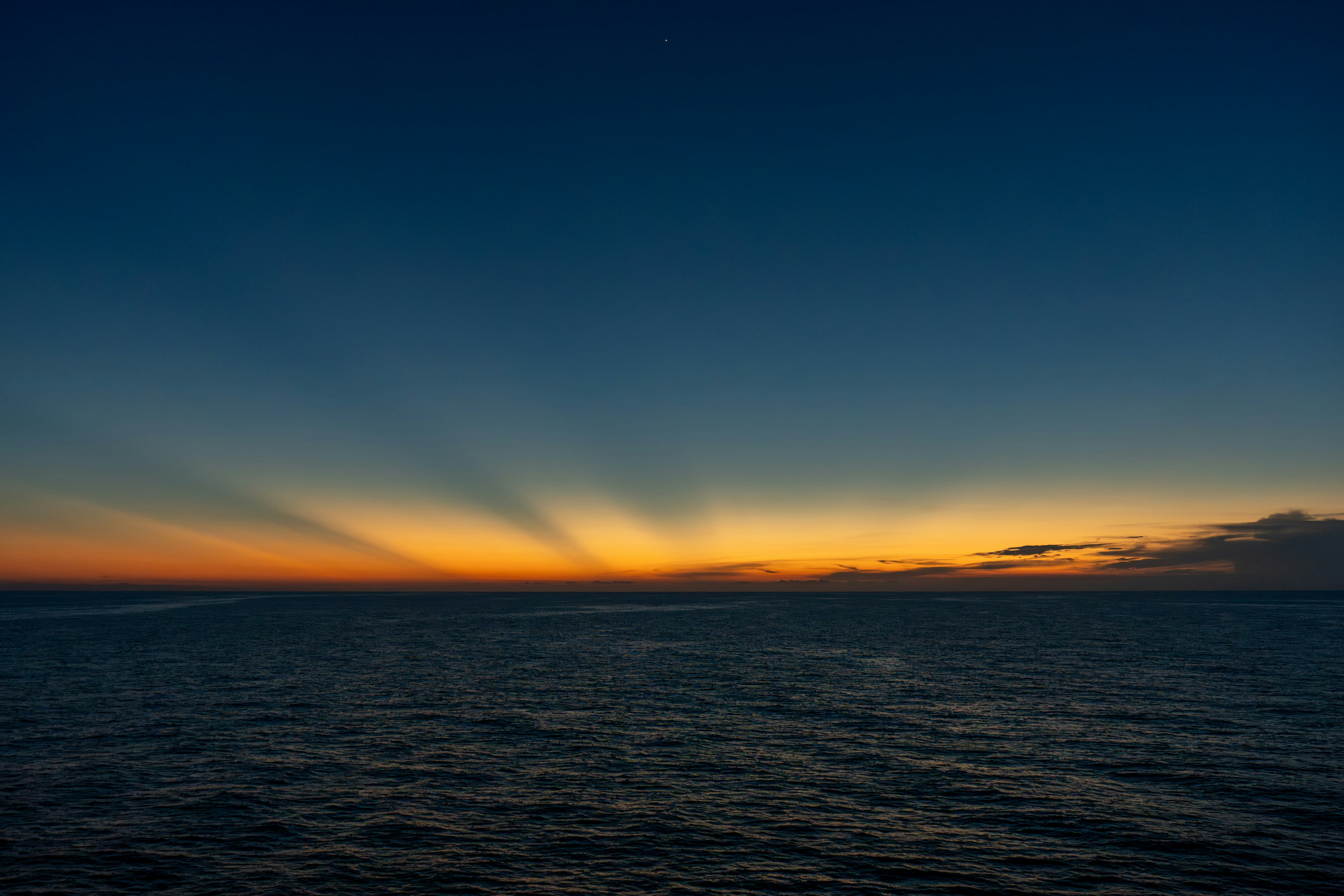 Dusk Horizon: Quiet Sea Embraces a Distant Star