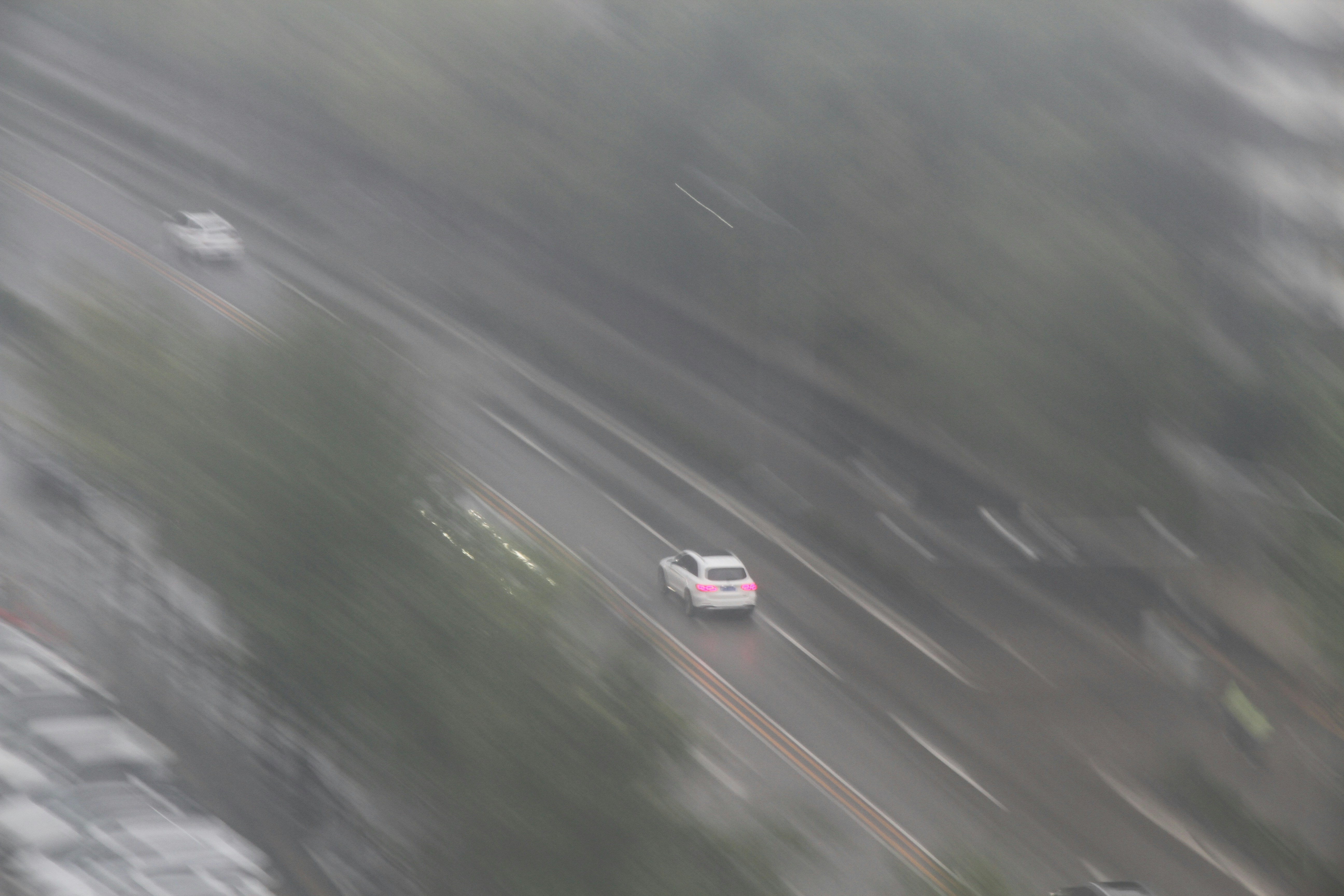 Blurry Highway Lapse: A White Car in Transit