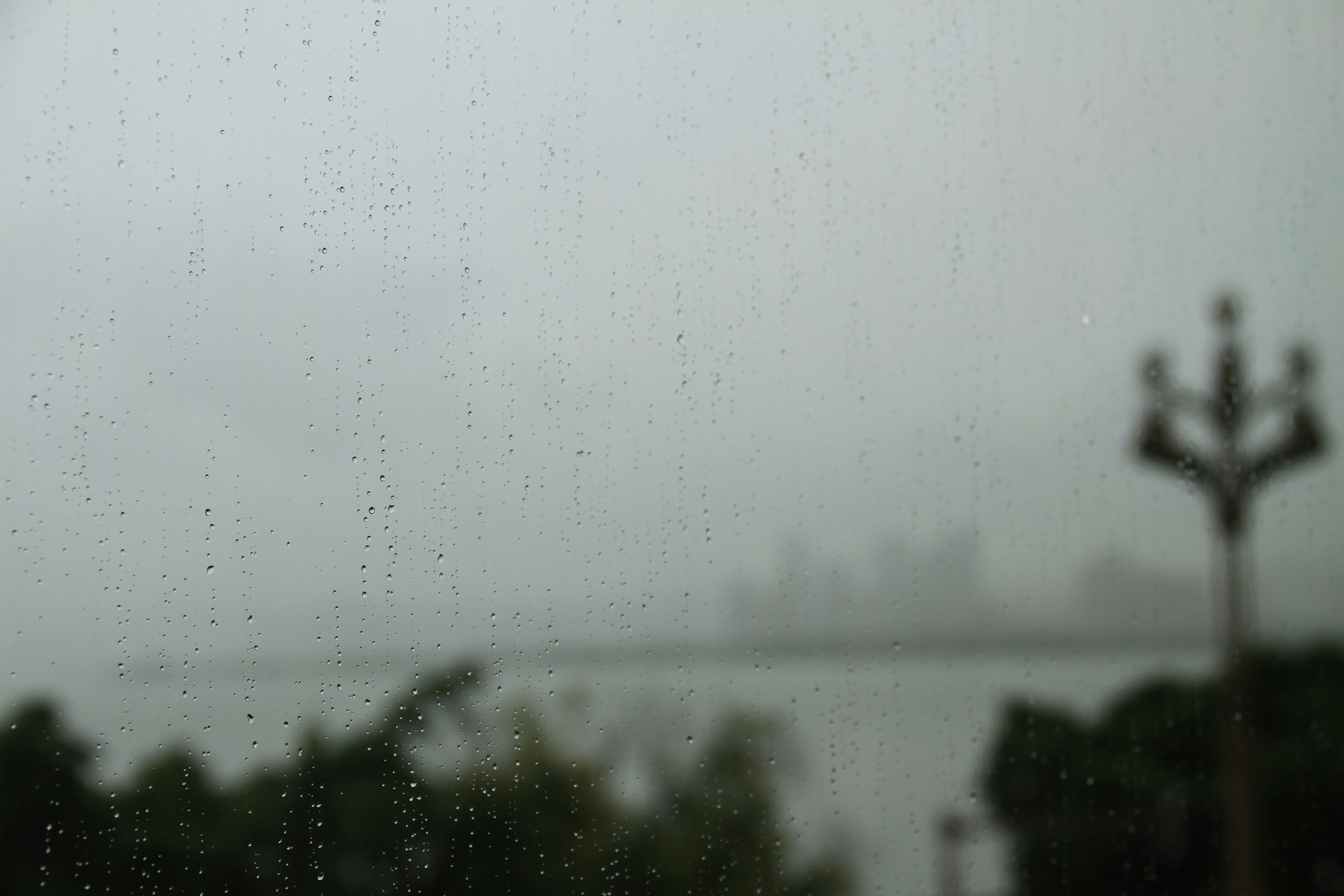 Rain on the Window: Blurred Cityscape Through Droplets