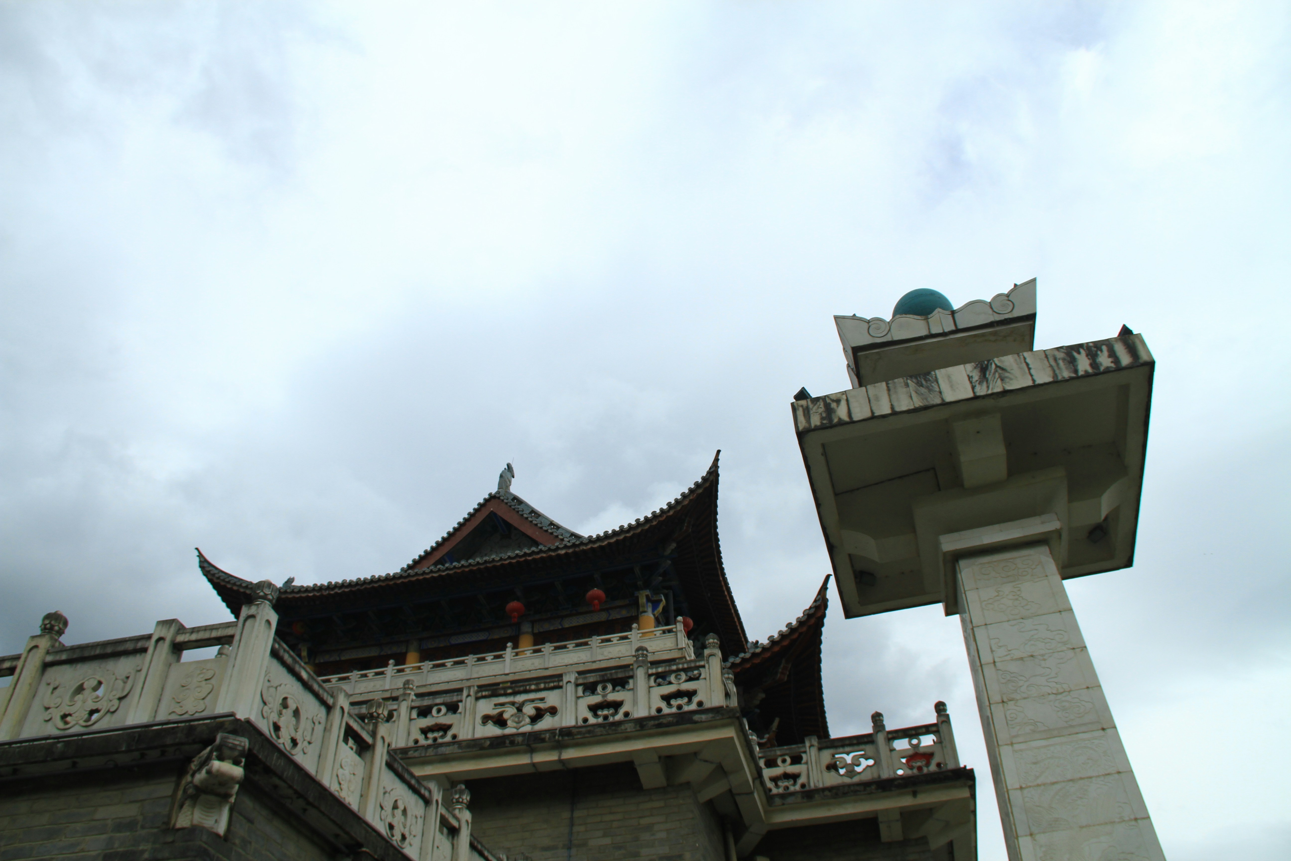Temple Balcony and Lantern Tower Against Cloudy Sky