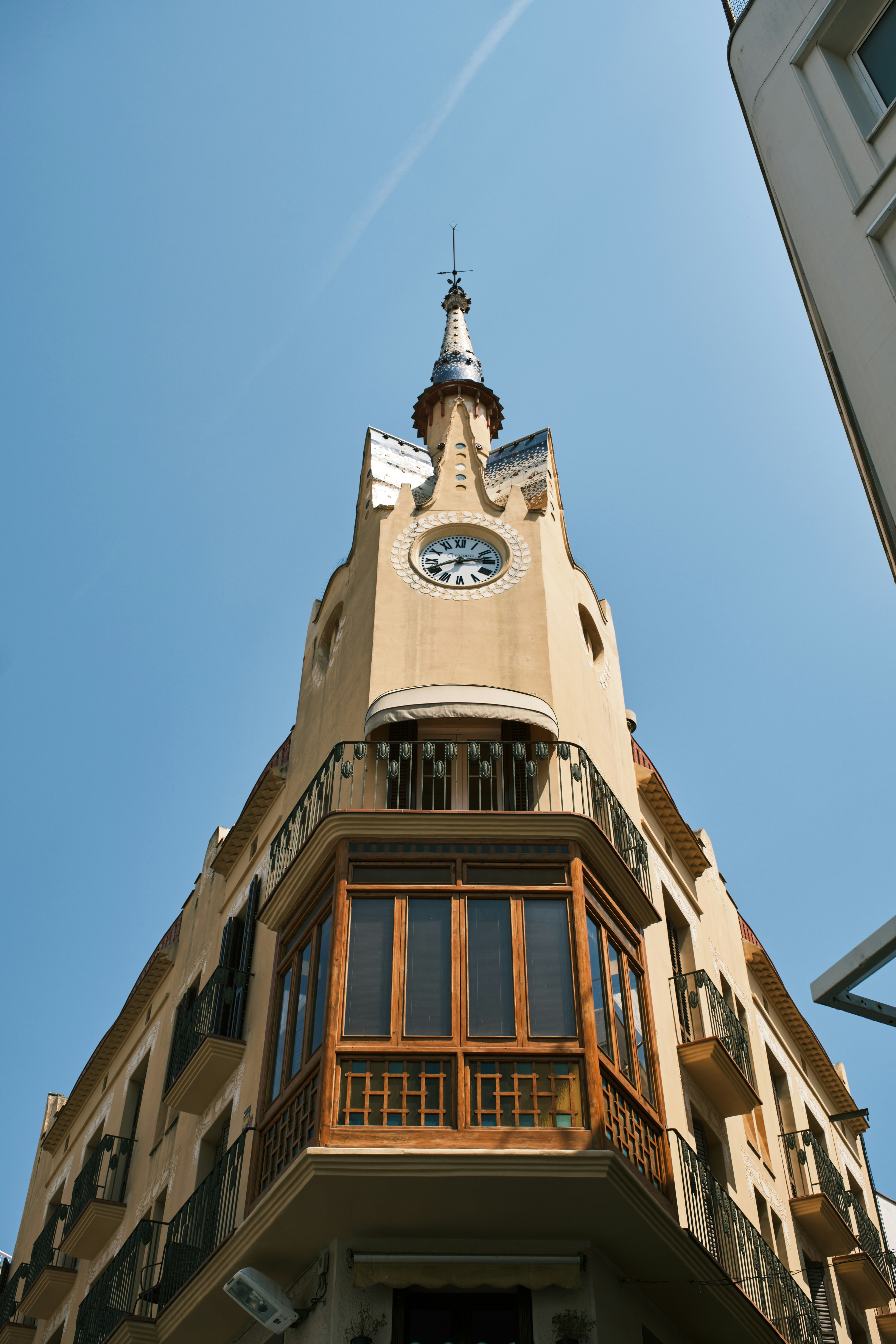 Clock Tower Crest Against Blue Sky