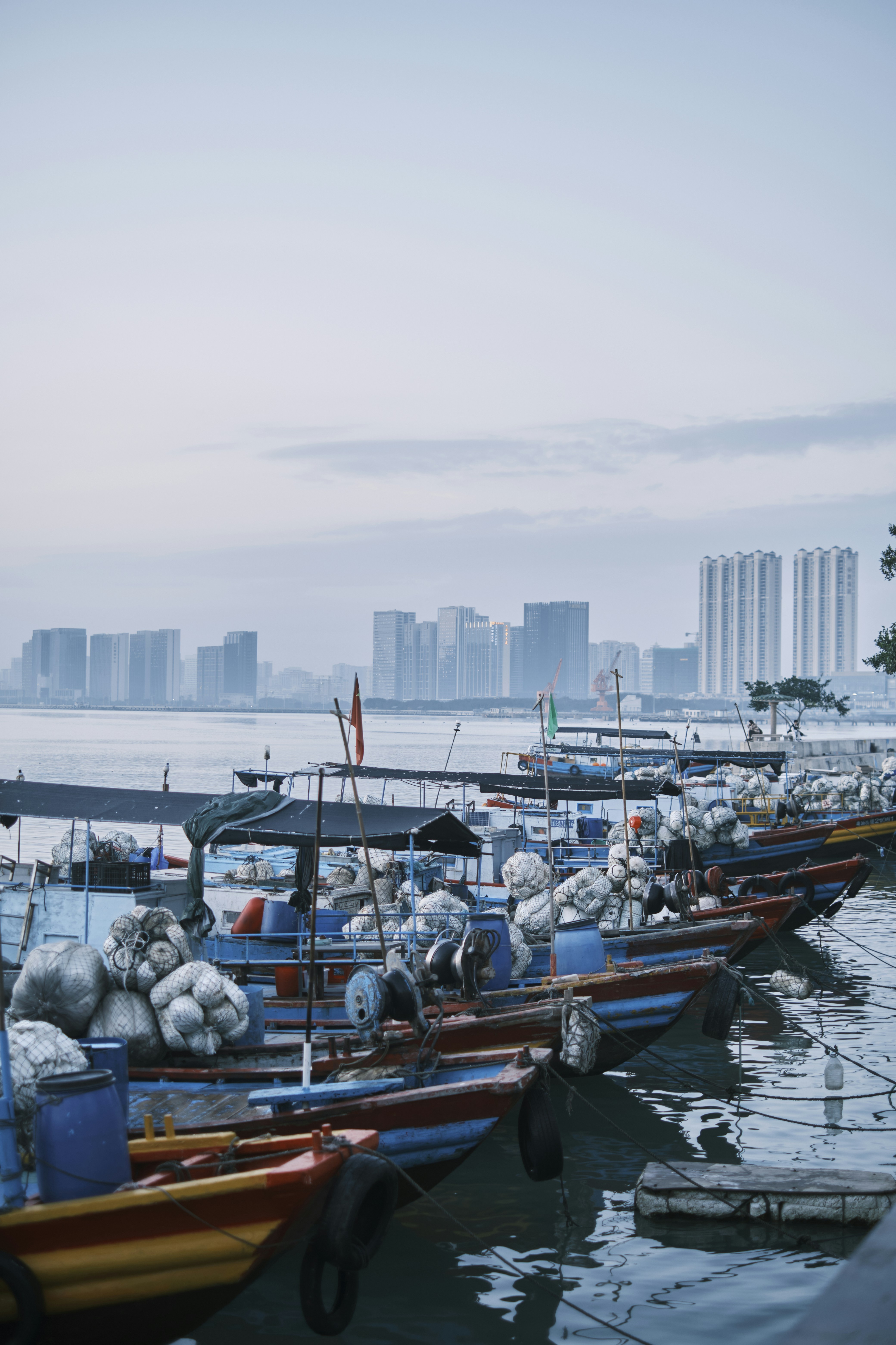 Harbor Lines: Boats at Dusk with Skyline Backdrop