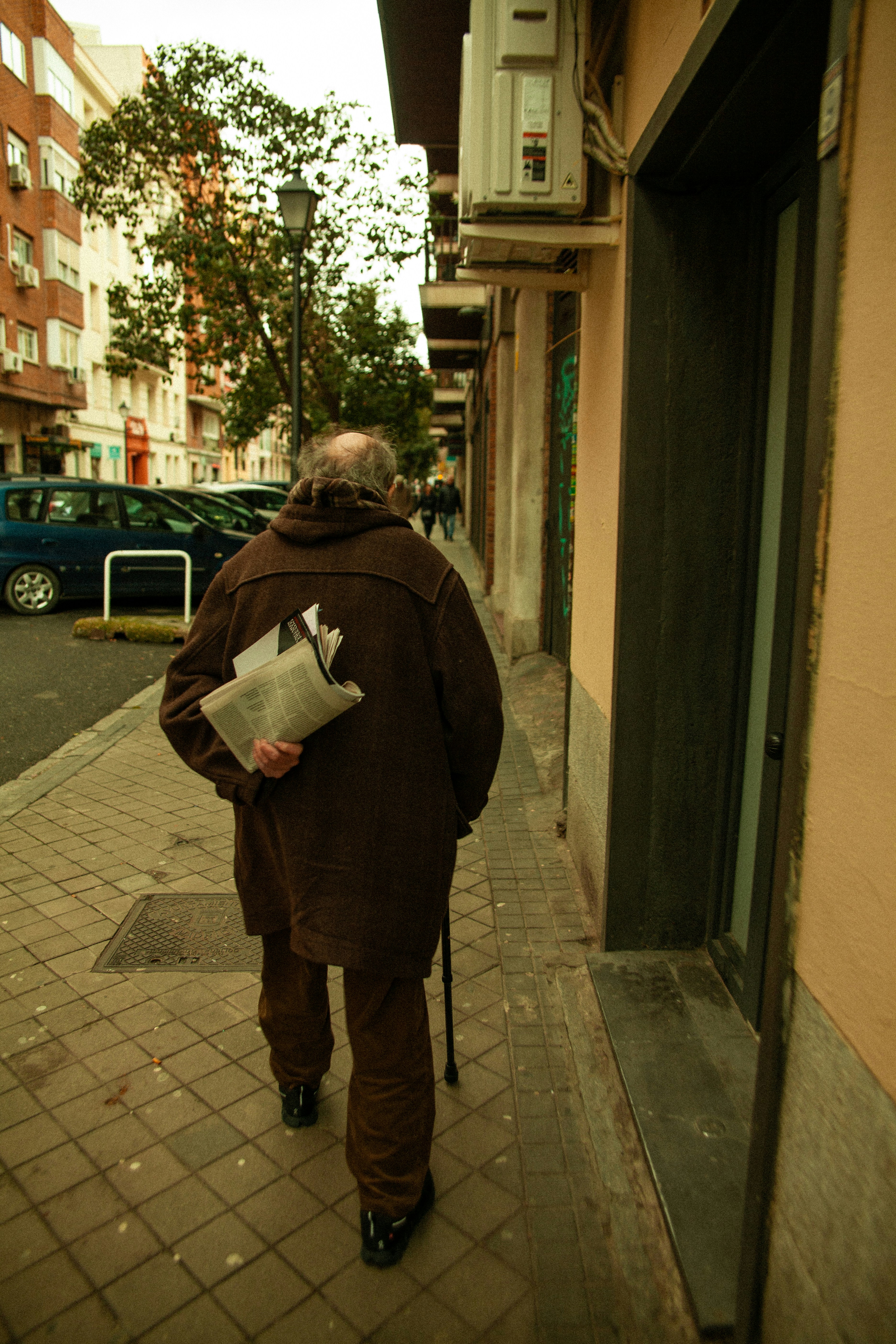 Striding with a Paper Trail: A Quiet Walk Along the City Sidewalk