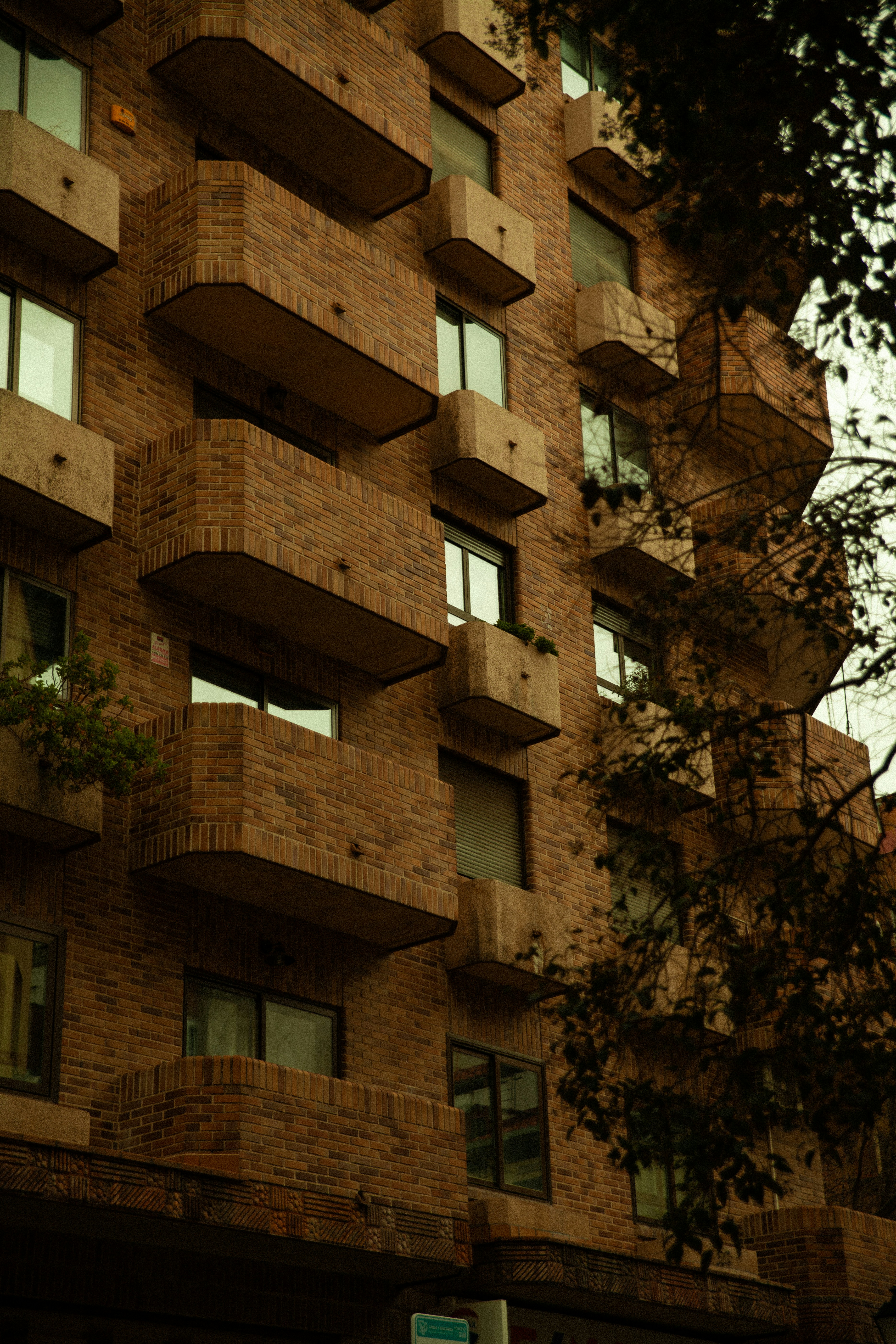 Brick Apartments: Repeating balconies under a Late Afternoon Cant