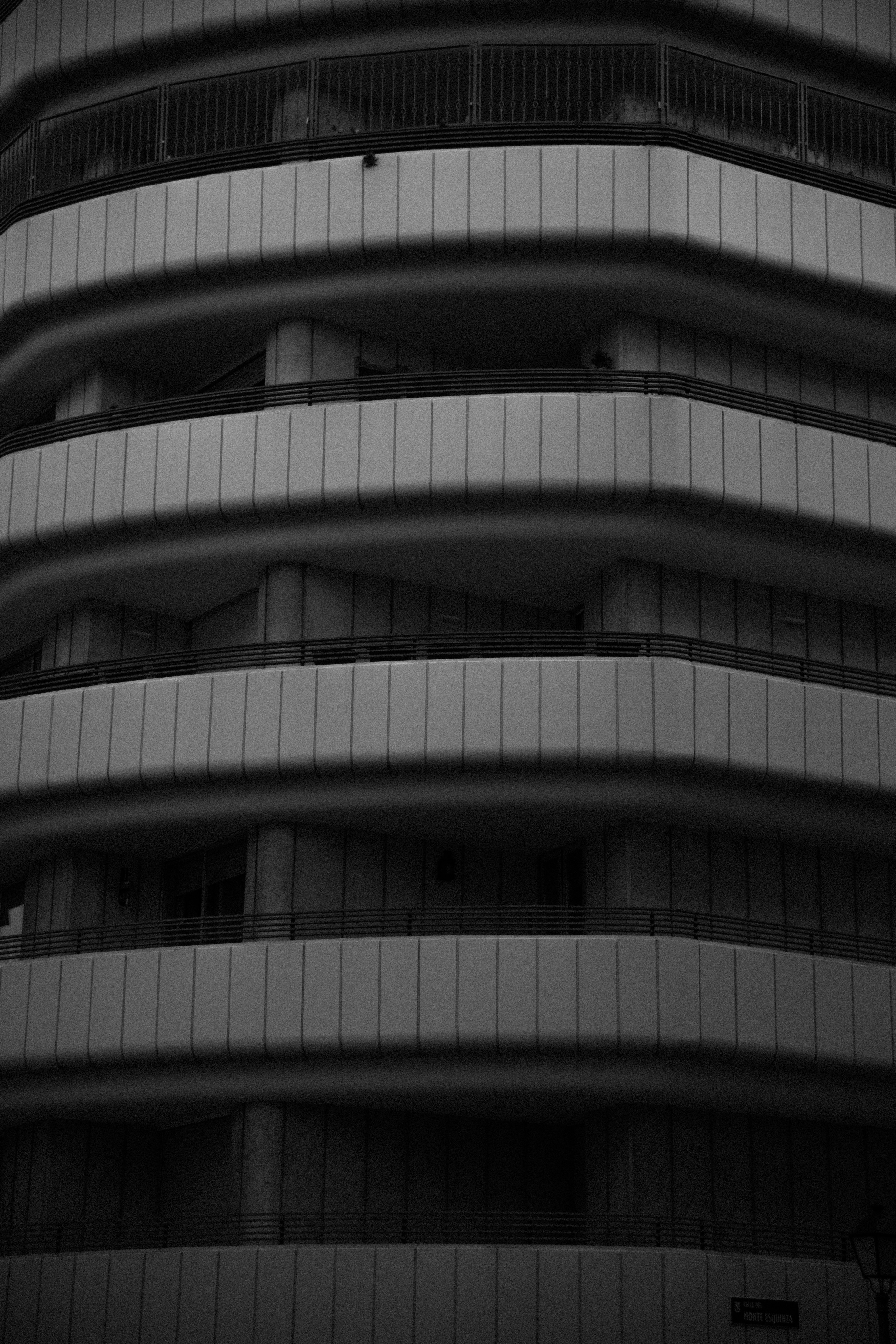 Vertical Echoes: Curved Balconies in Monochrome Rhythm