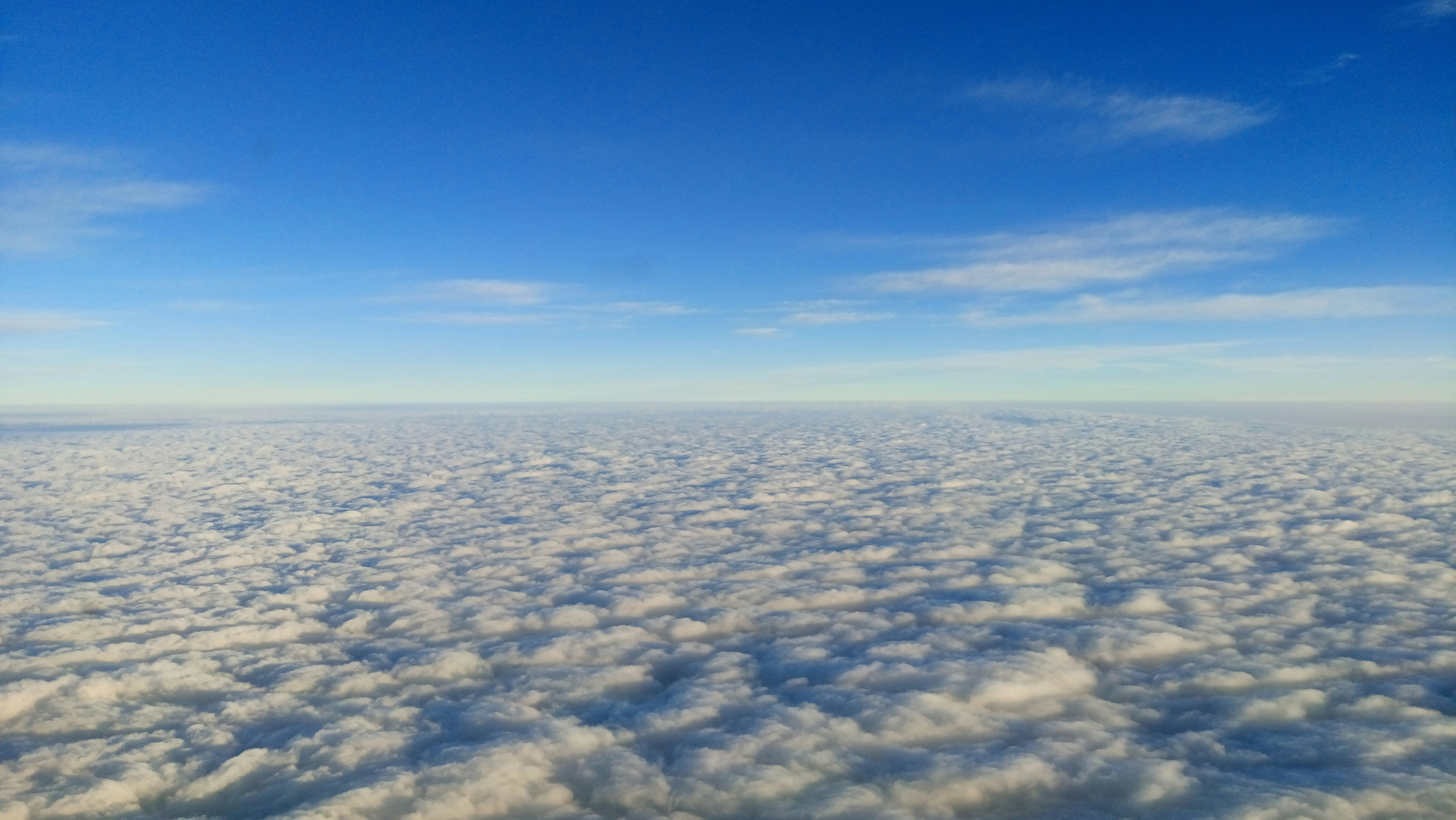 Above the Sea of Clouds: Clear Horizon Under a Blue Dawn