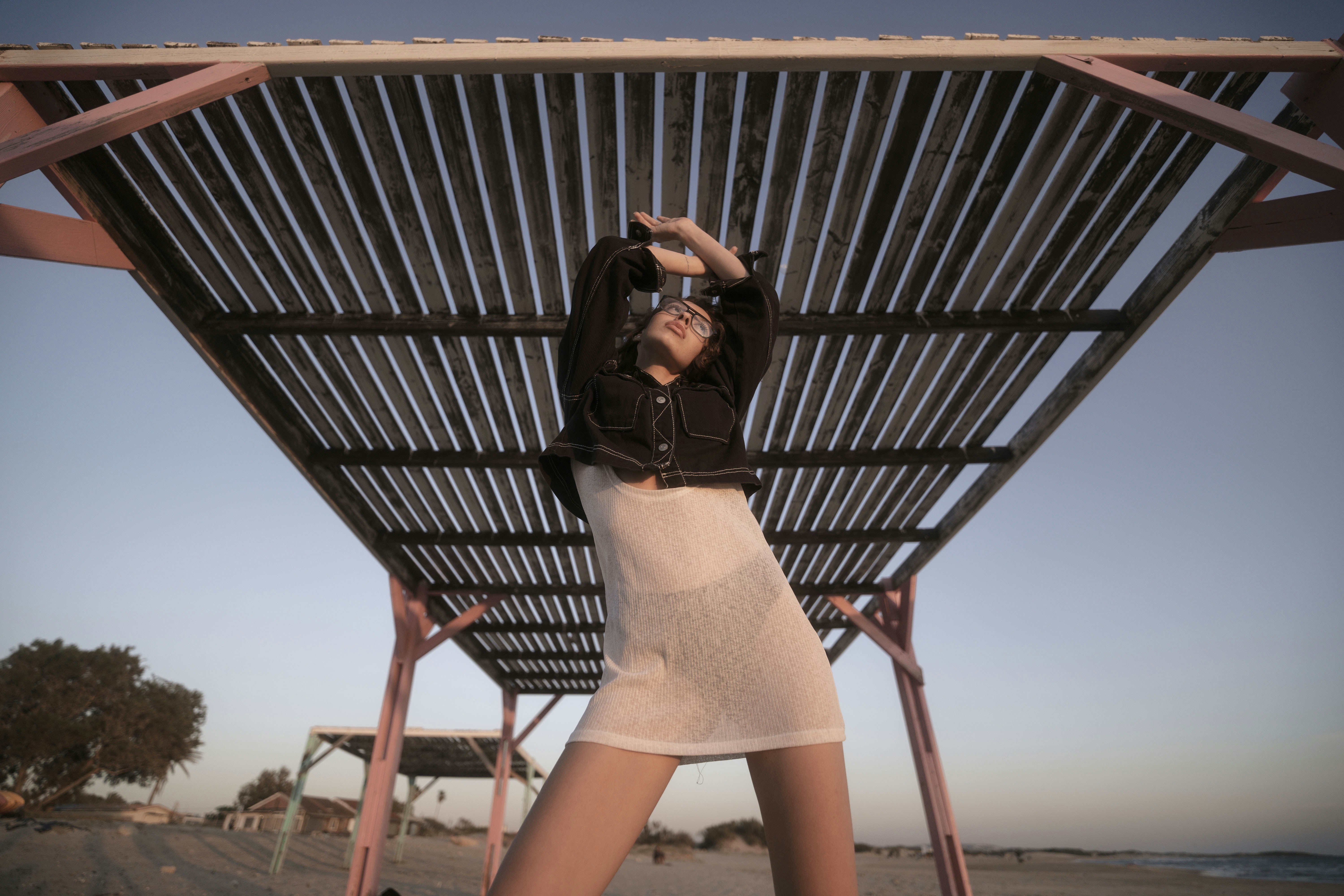 Under the Sunlit Framework: A Bold Pose Beneath the Metal Pergola