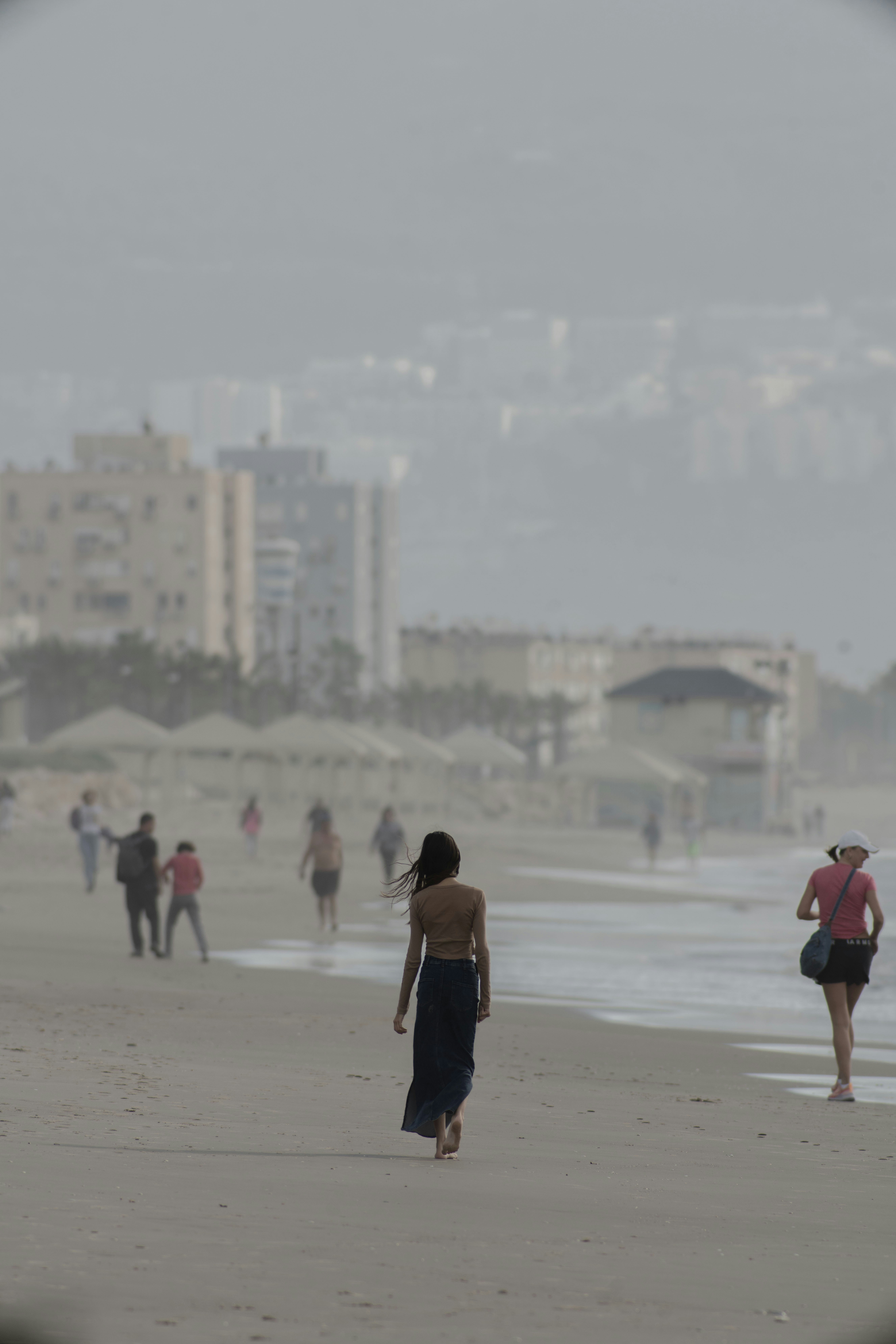 Walking Toward the Horizon on a Misty Beach