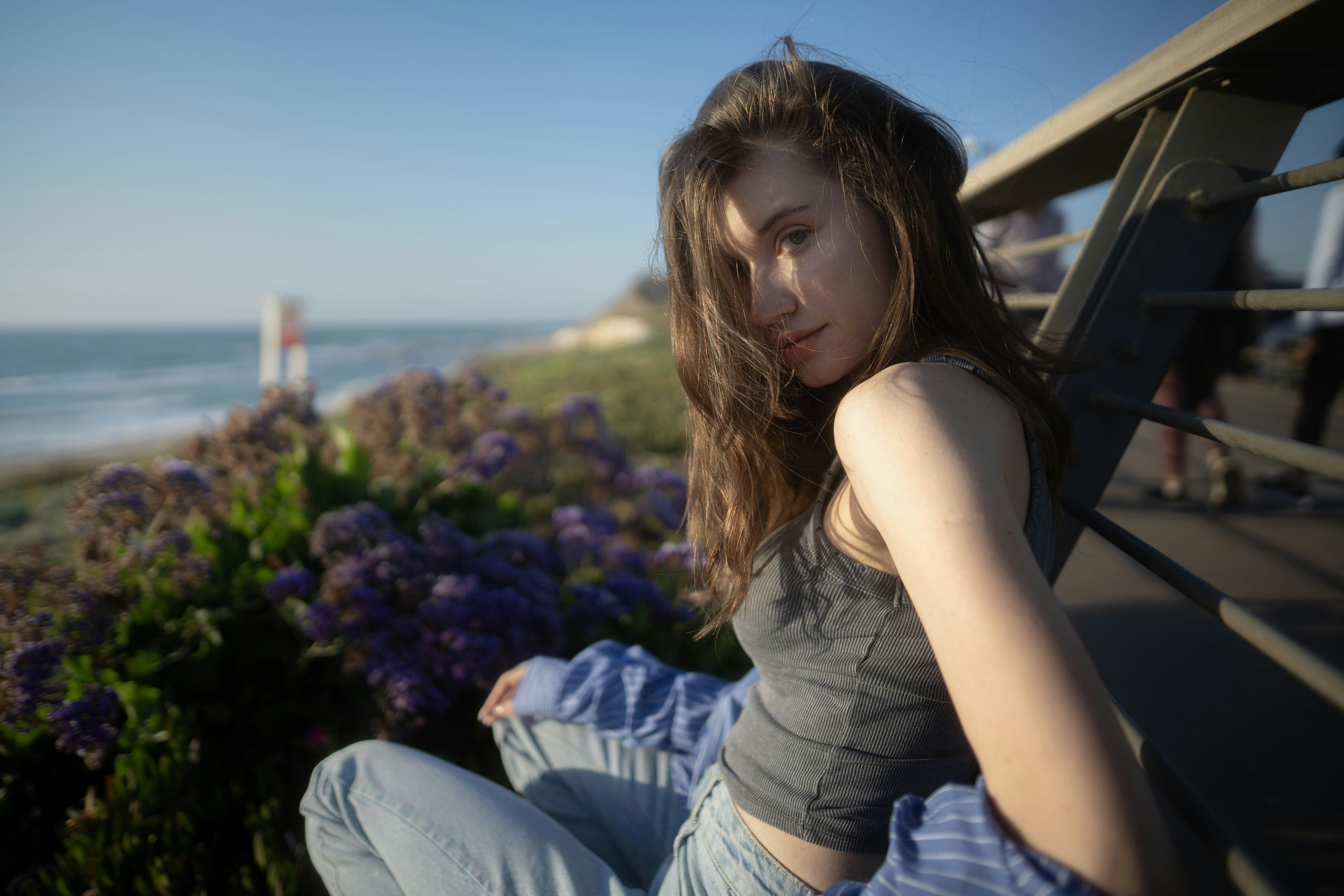 Sunlit Moment: A Coastal Portrait Framed by Bouquets and Ocean