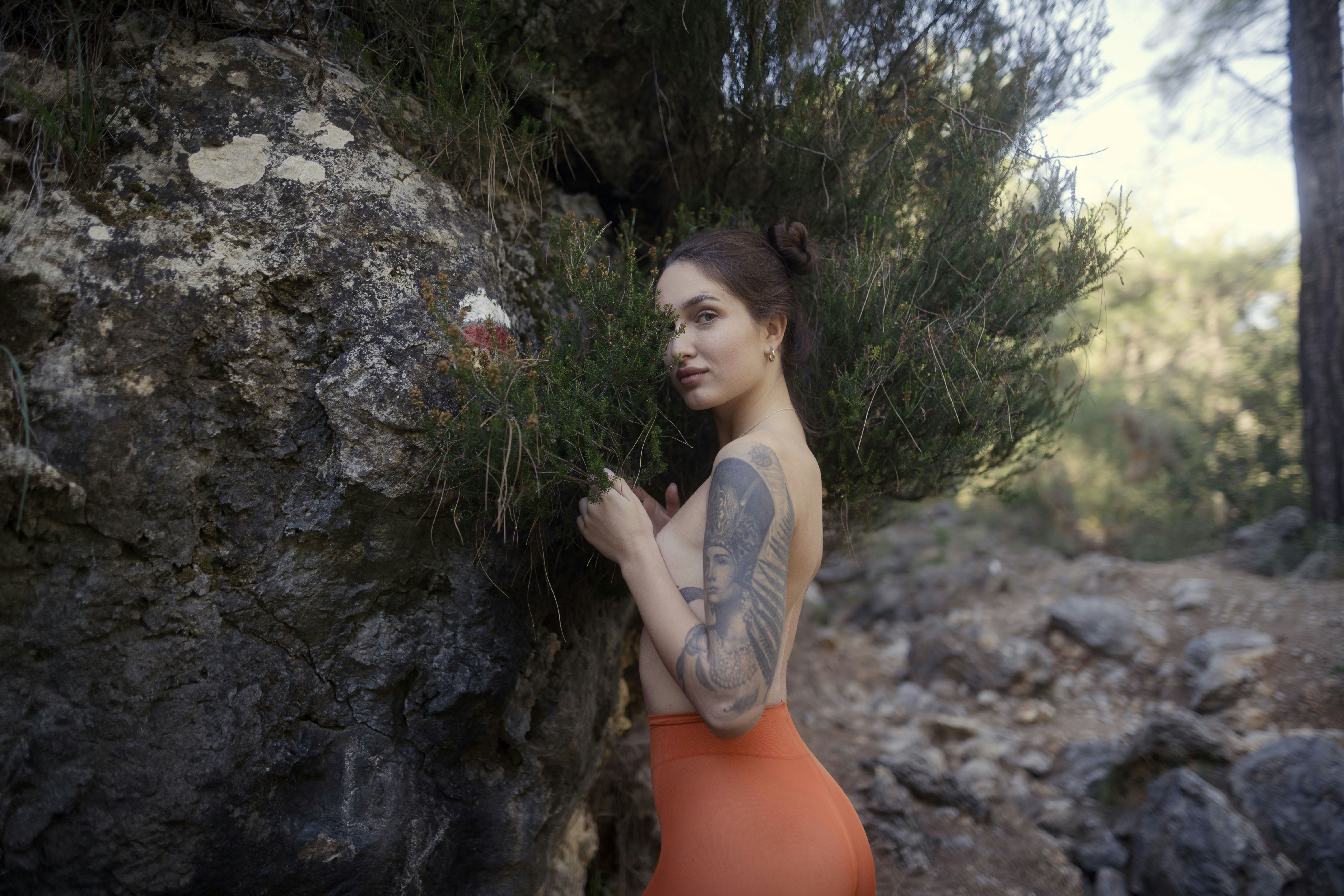 Tattooed silhouette: a portrait against a rocky hillside